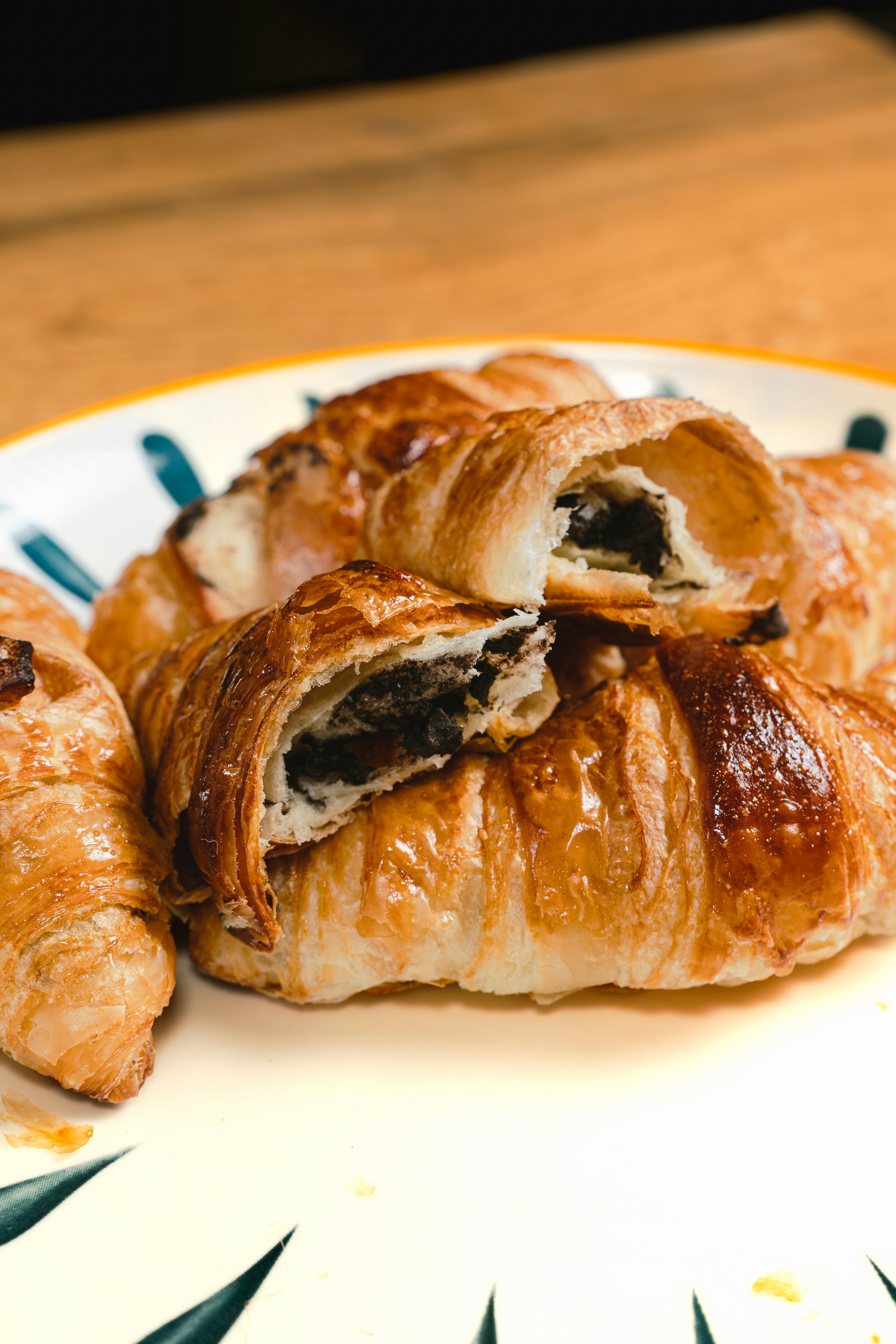 Golden Pastry Stack: Croissants with Dark Chocolate Center on a Plate