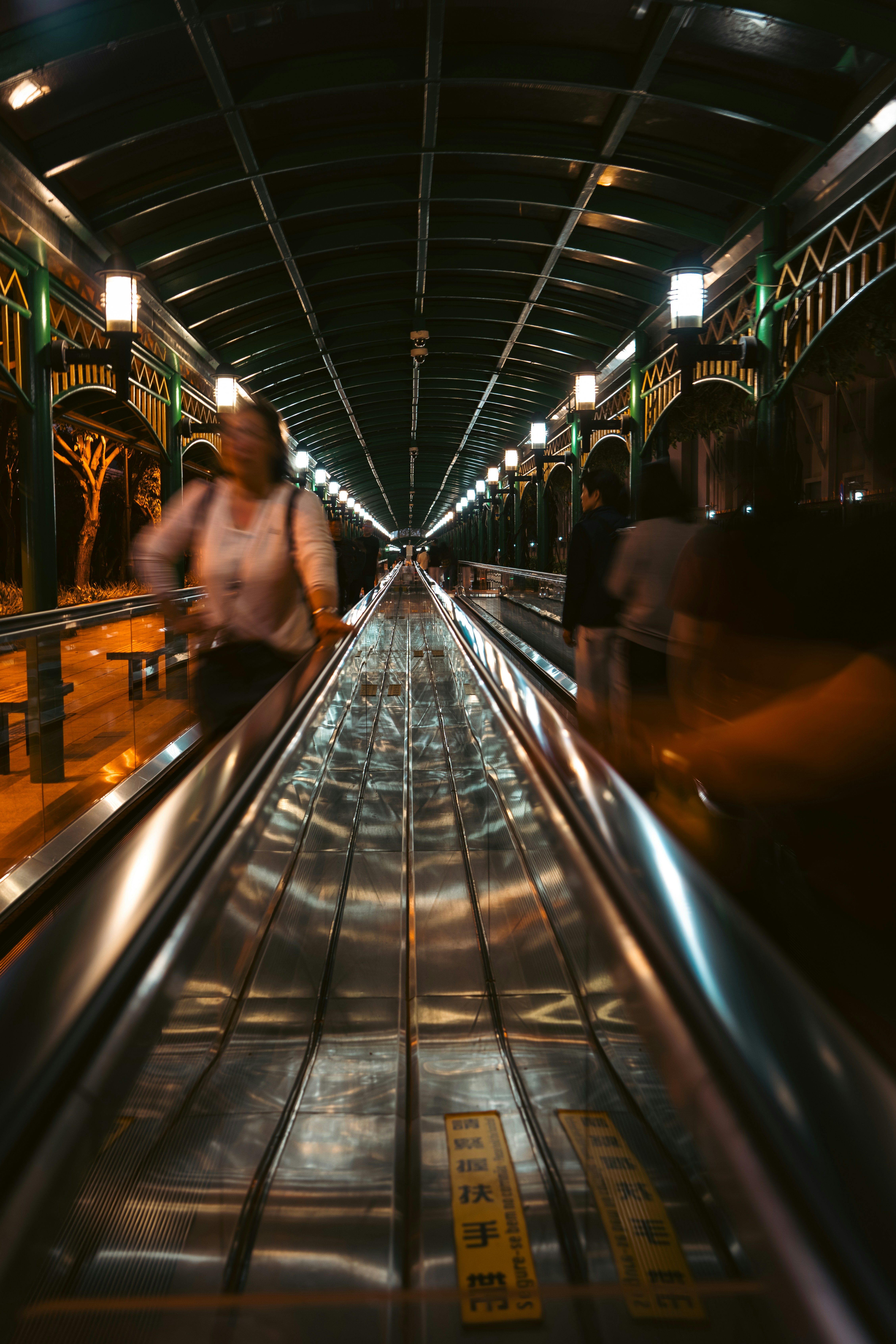 Motion in the Glass Tunnel: A Night Run on the Moving Steps