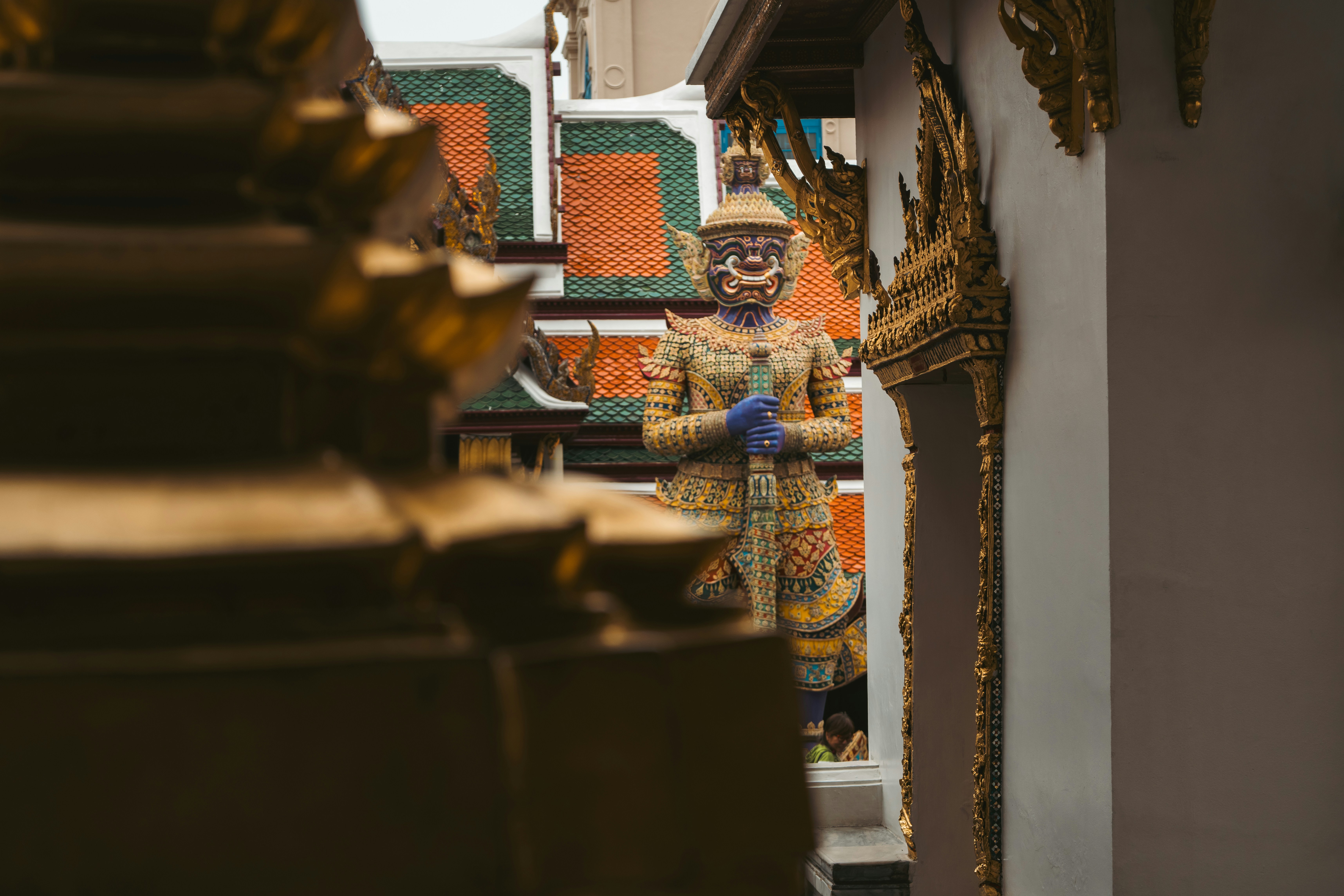 Guardian in Color: A Temple Sentinel Framed Between Ornate Pillars