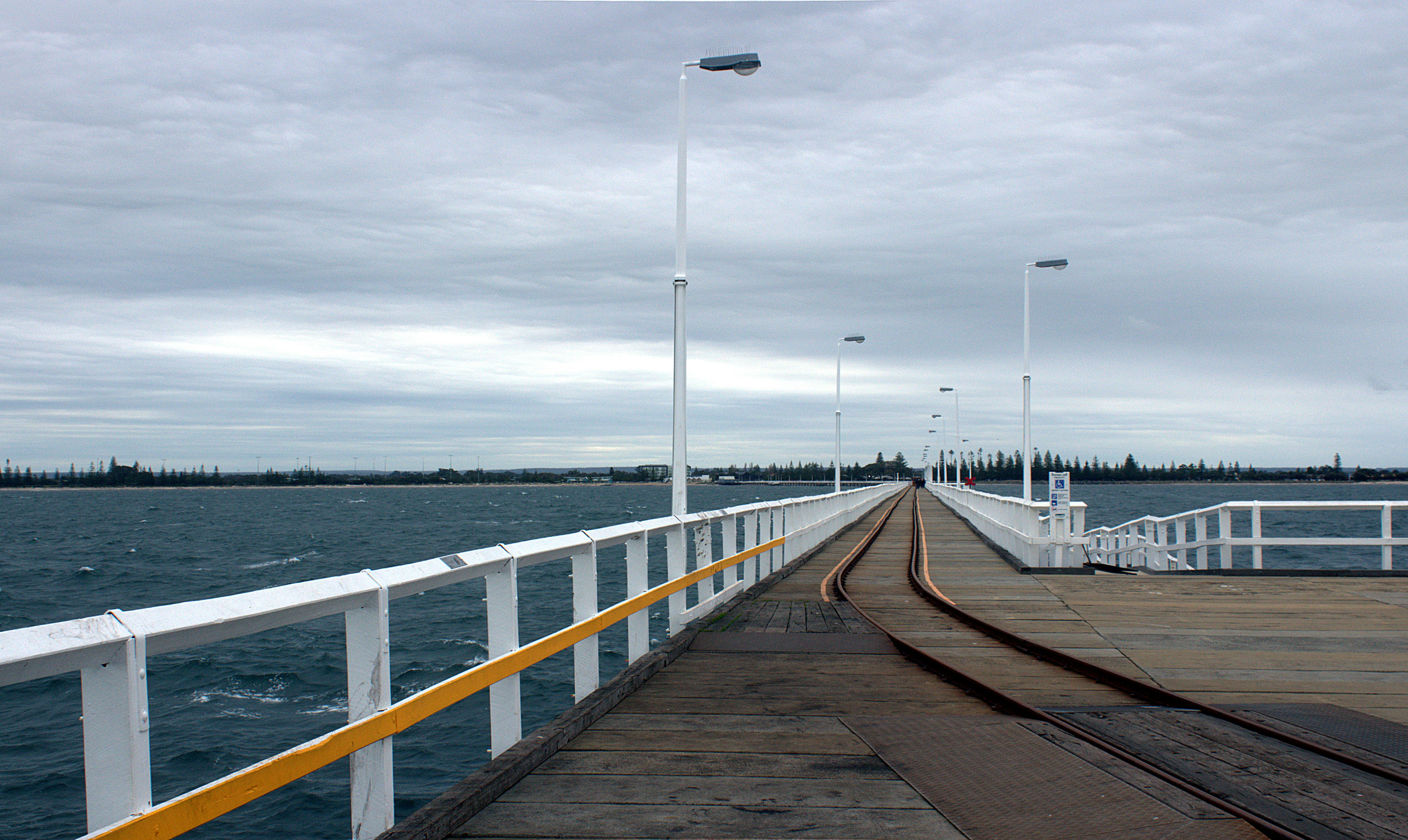 Pier to the Horizon: Rails Curving Toward the Sea