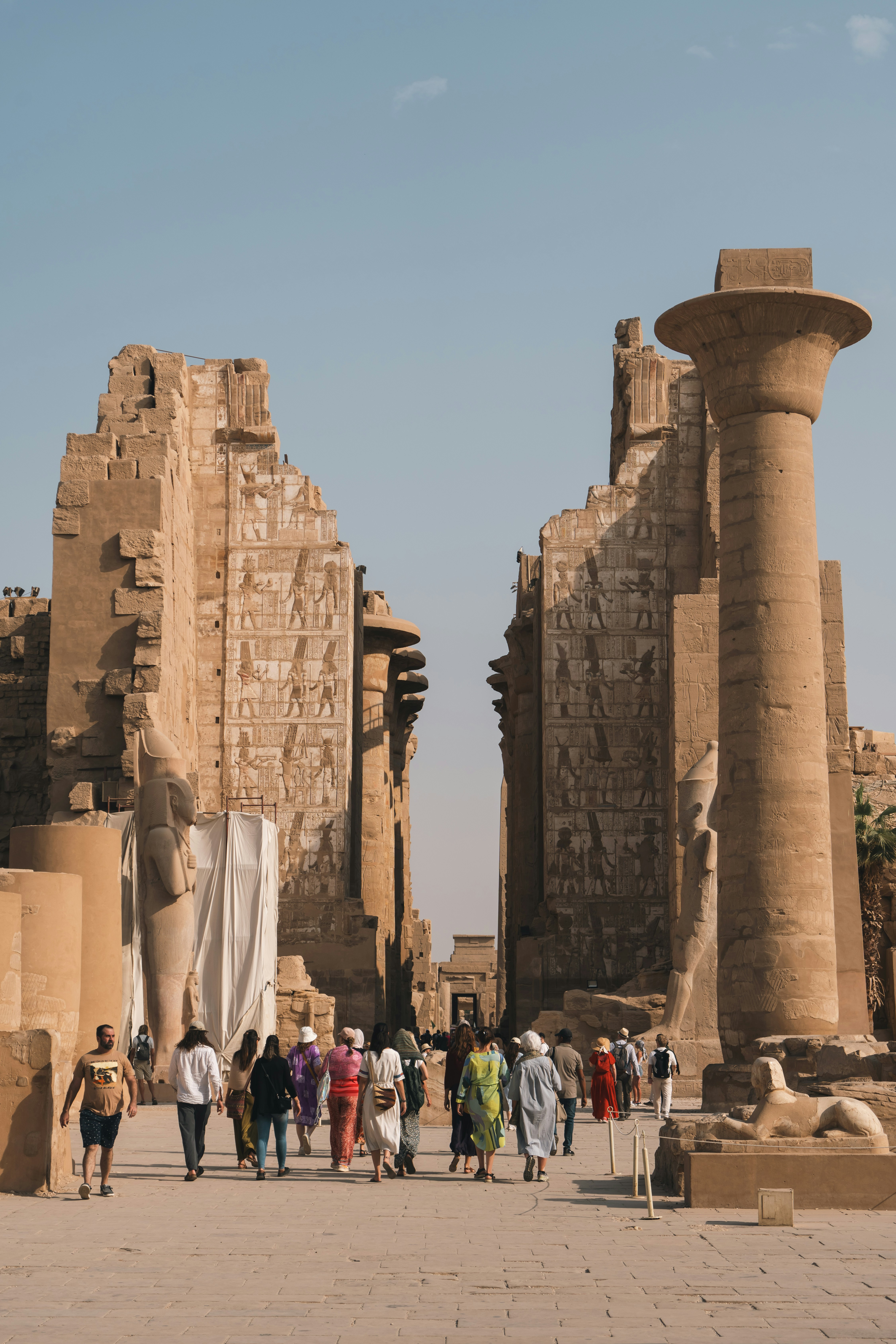 Whispering Columns of Karnak: Travelers Beneath the Ruined Colonnade