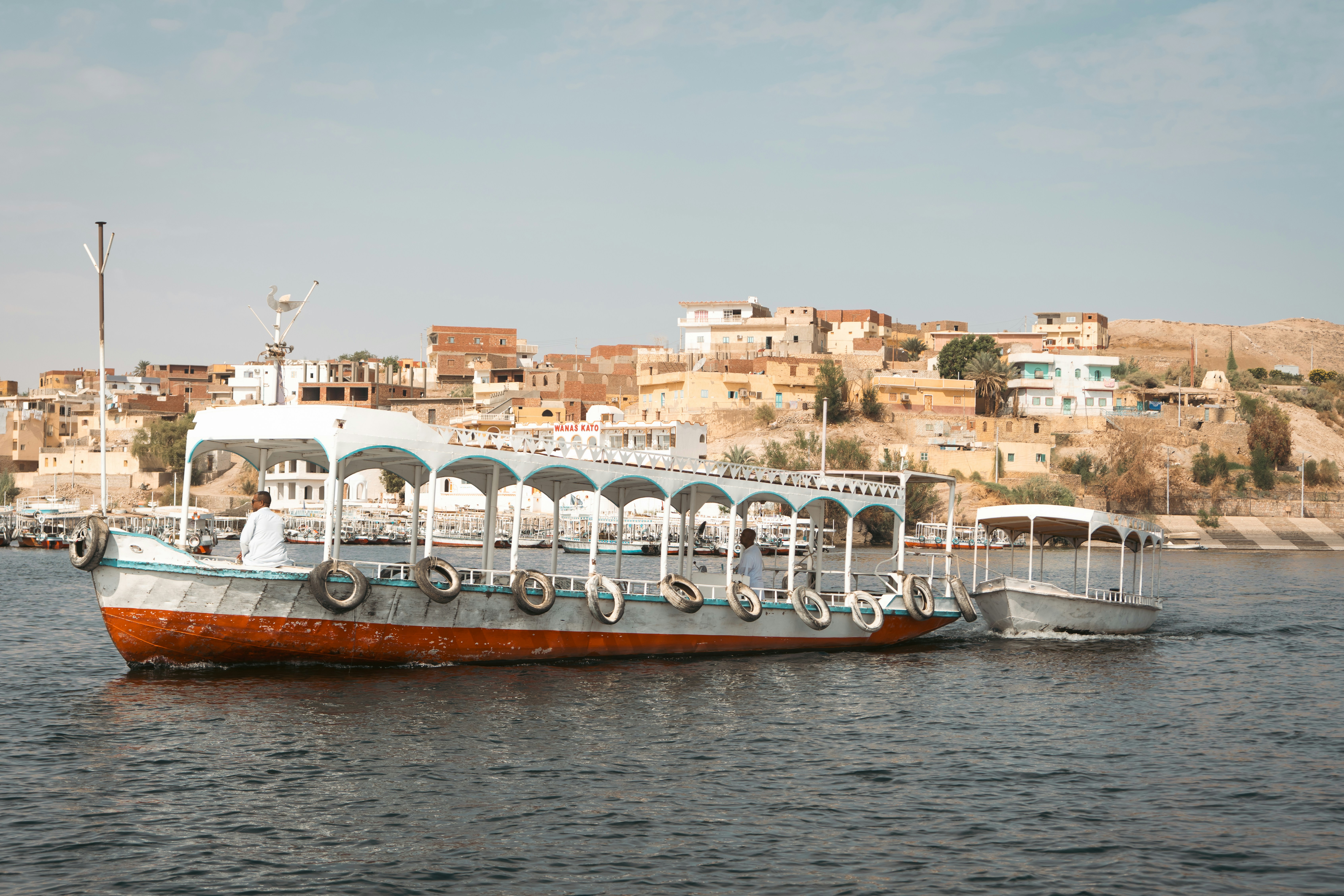 A Quiet Harbor Vessel Gently Riding the Tides Against a Hushed Inland Quarter