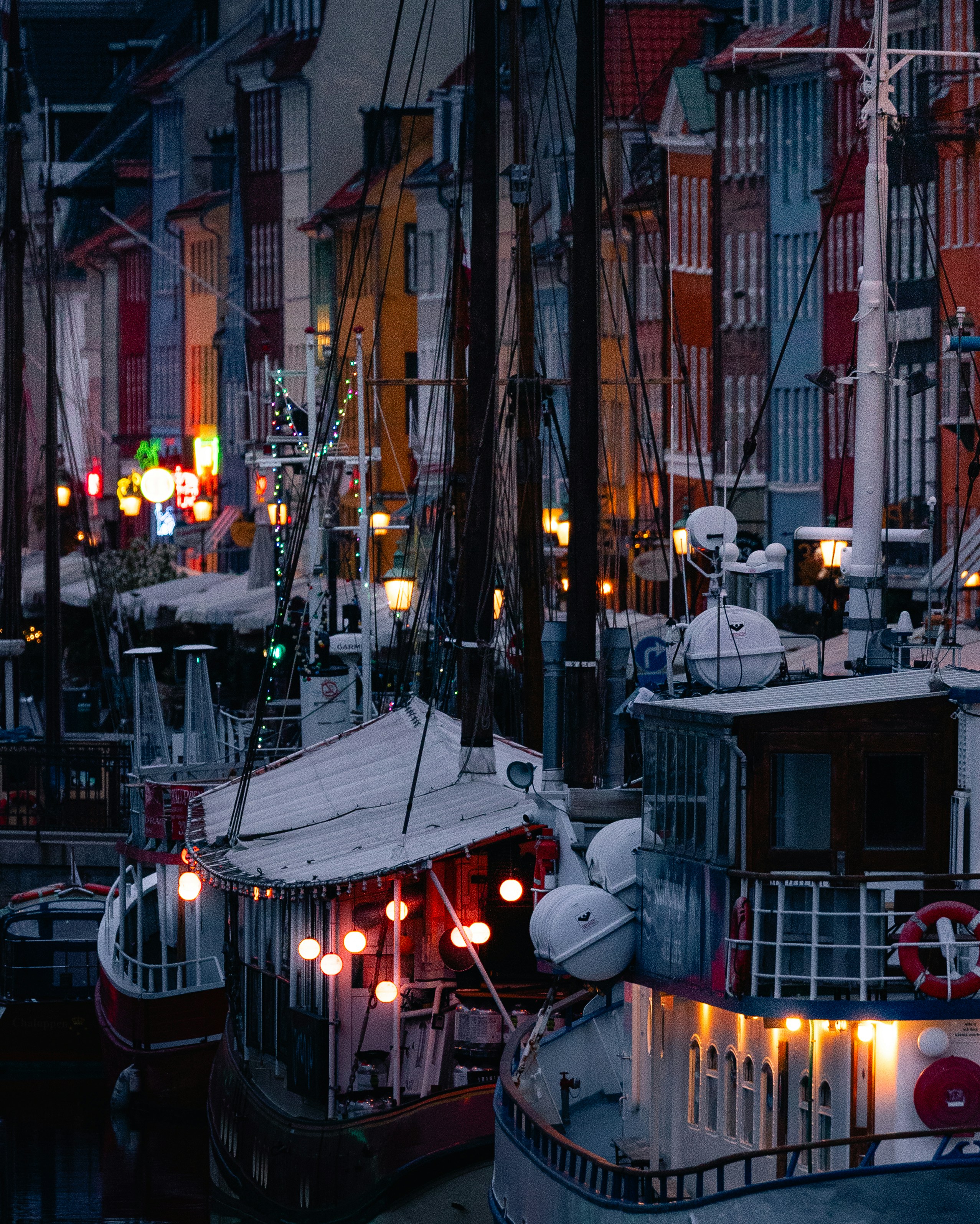 Neon Harbor: Night Boats Illuminated in a Quiet Dockscape