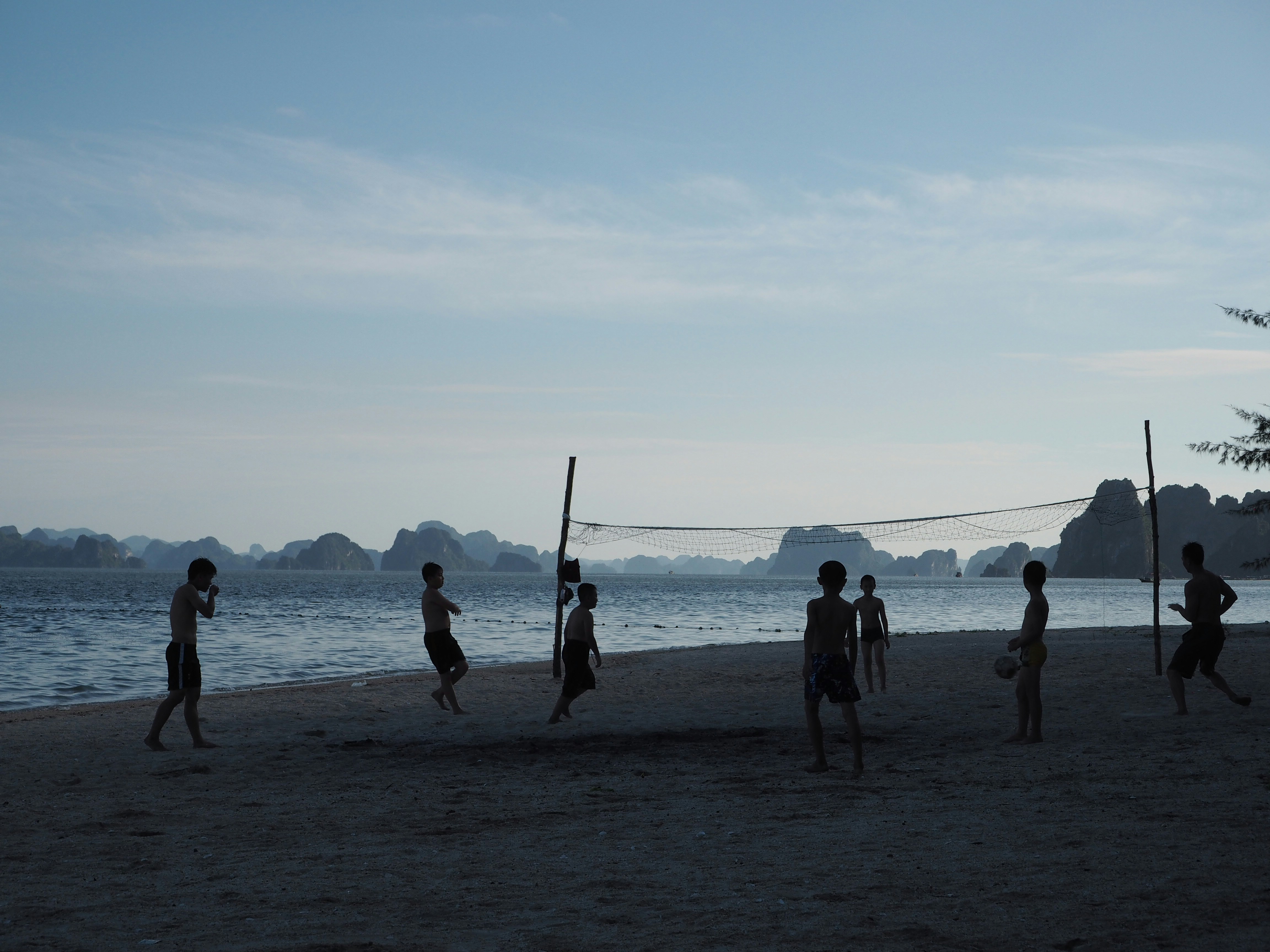 Silhouetted Beach Players at Dusk