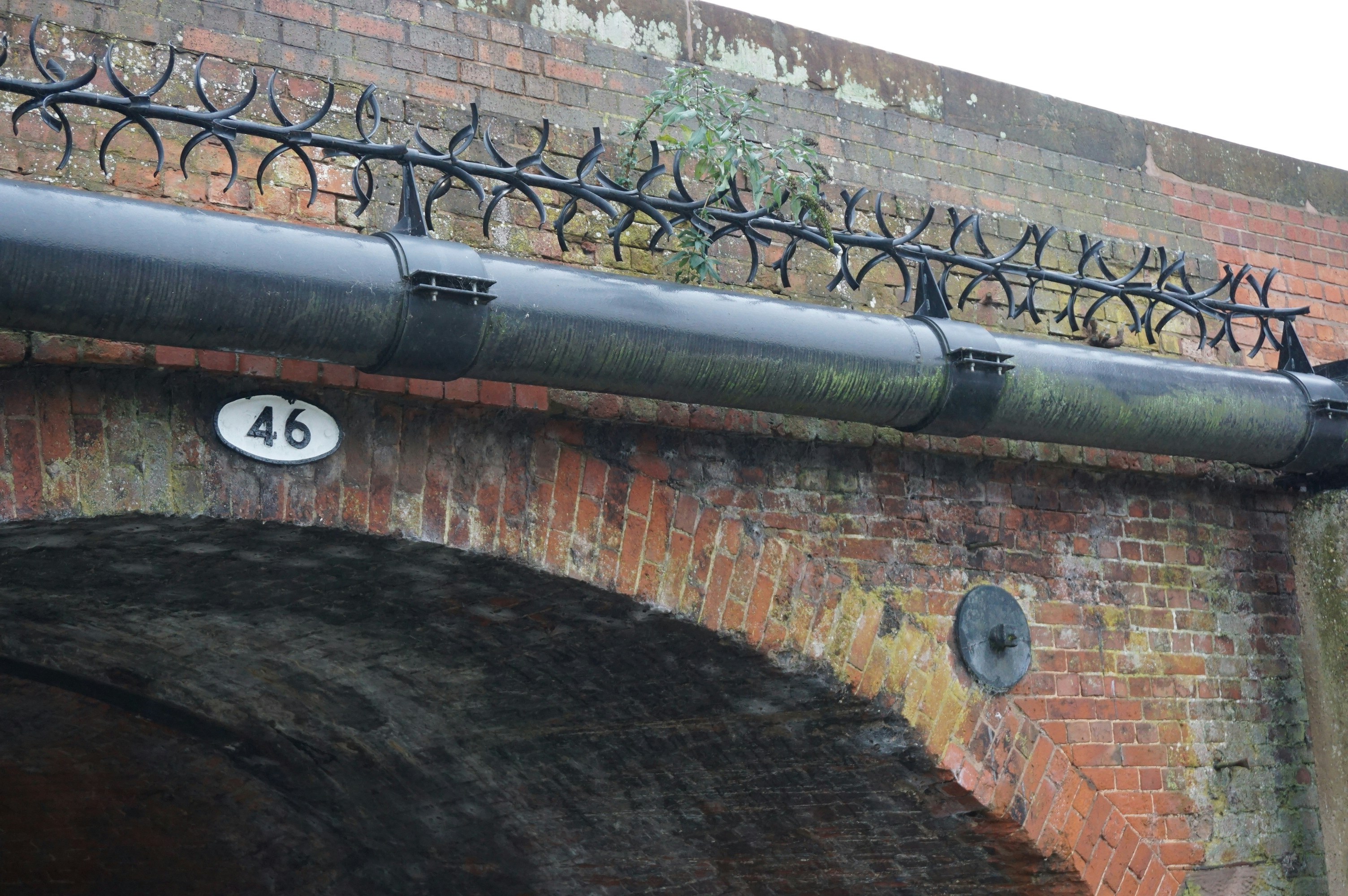 Brick Arch Underpass with Vintage Railings and Gutter