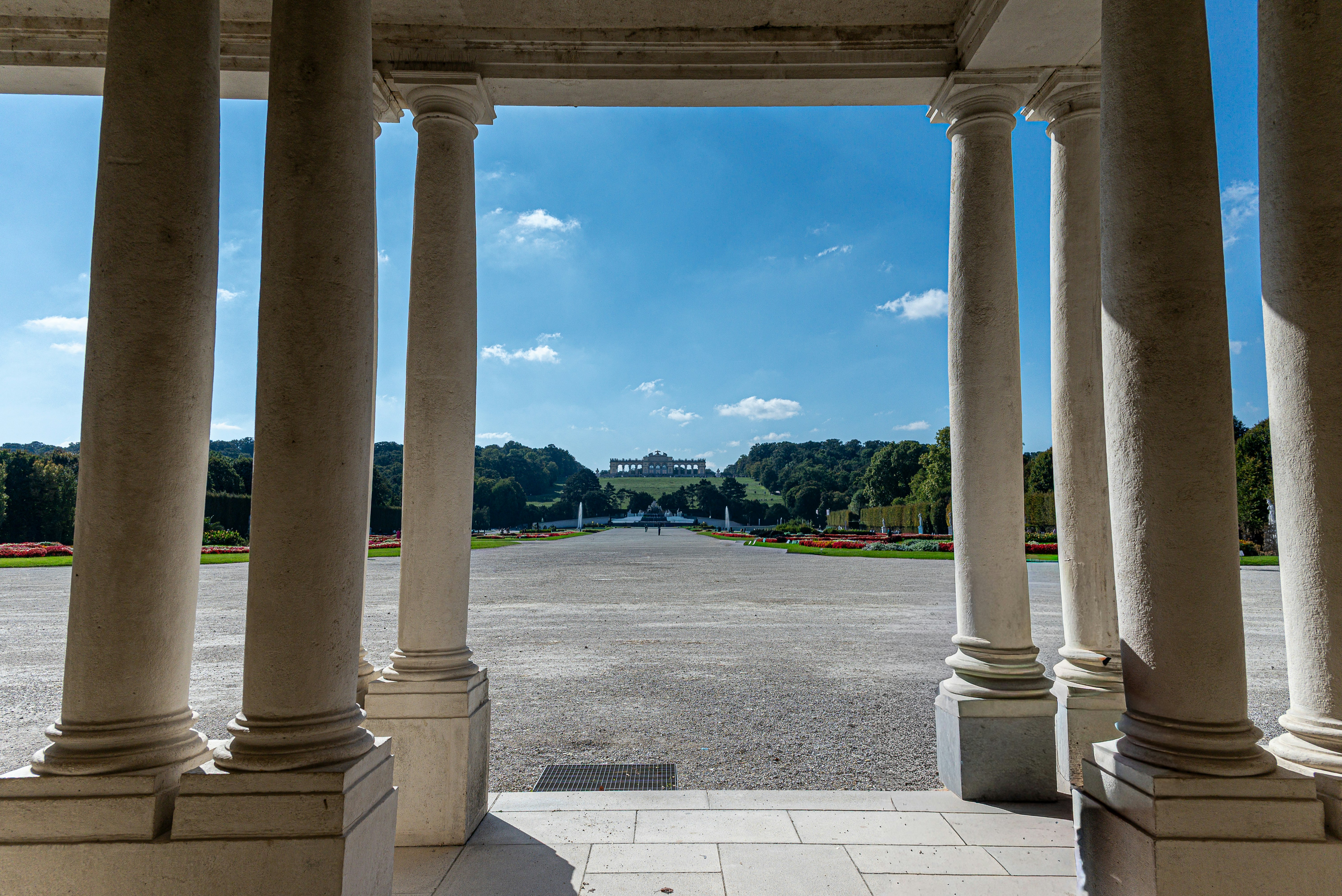 Colonnade Frame: Pathway to the Monument Under a Clear Sky