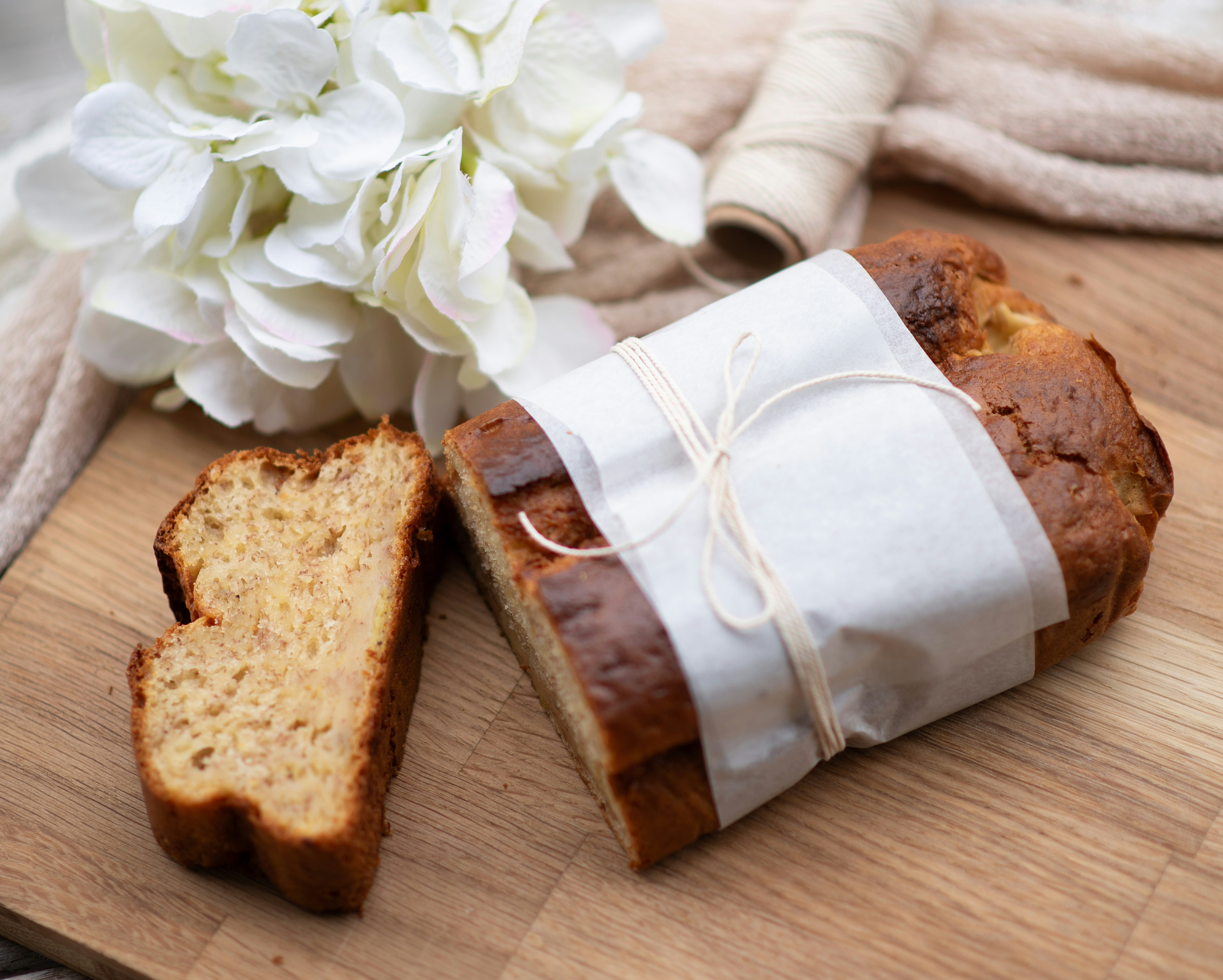 A loaf of citrus-vanilla pound cake fresh on a wooden board