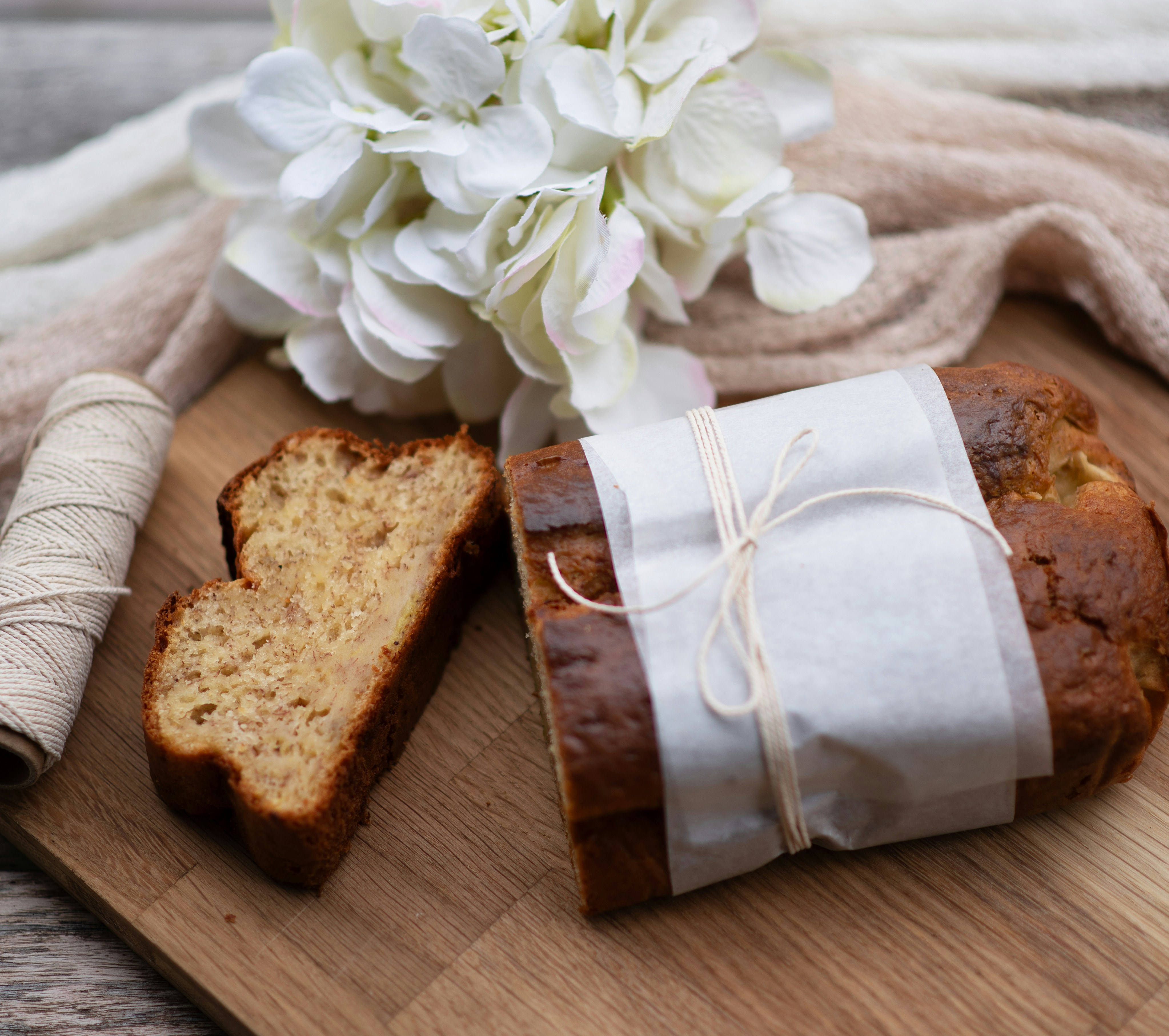 Gentle Toast and Bloom: A Wooden Board Still-Life with Pound Cake and Hydrangeas