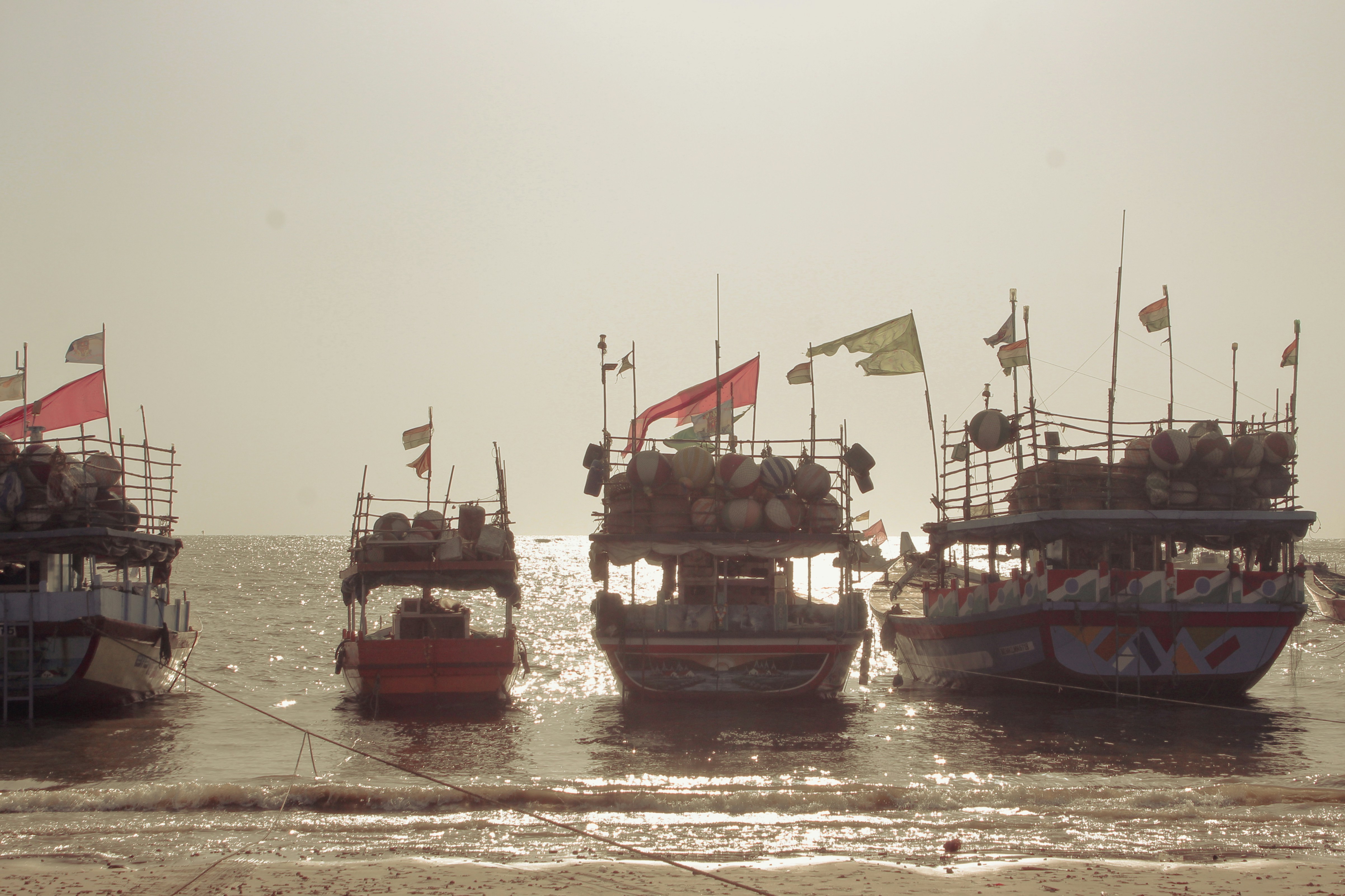 Flotilla of Flagged Vessels at Dusk