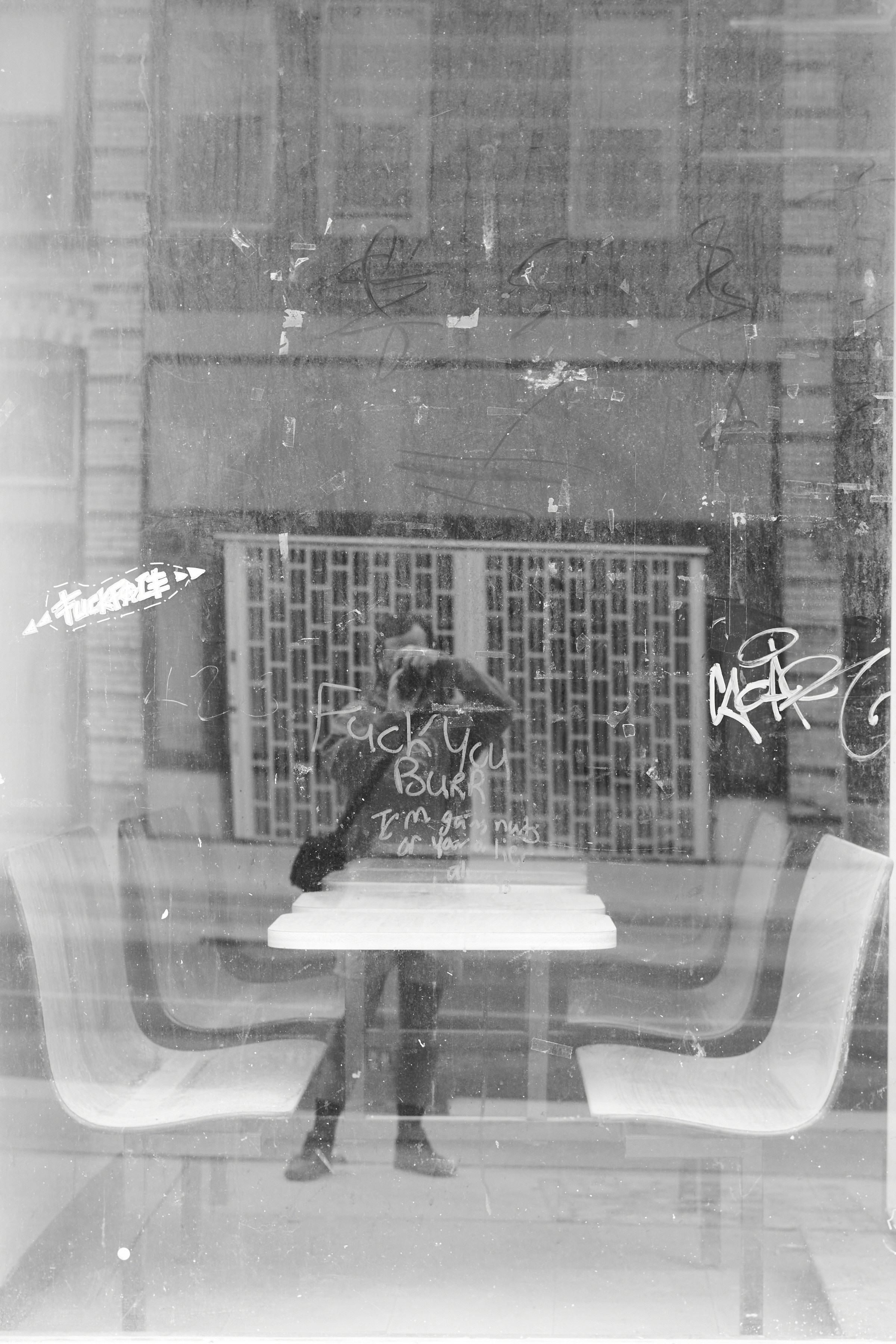 Graffiti Reflection: A Quiet Table Portrait in a City Fade