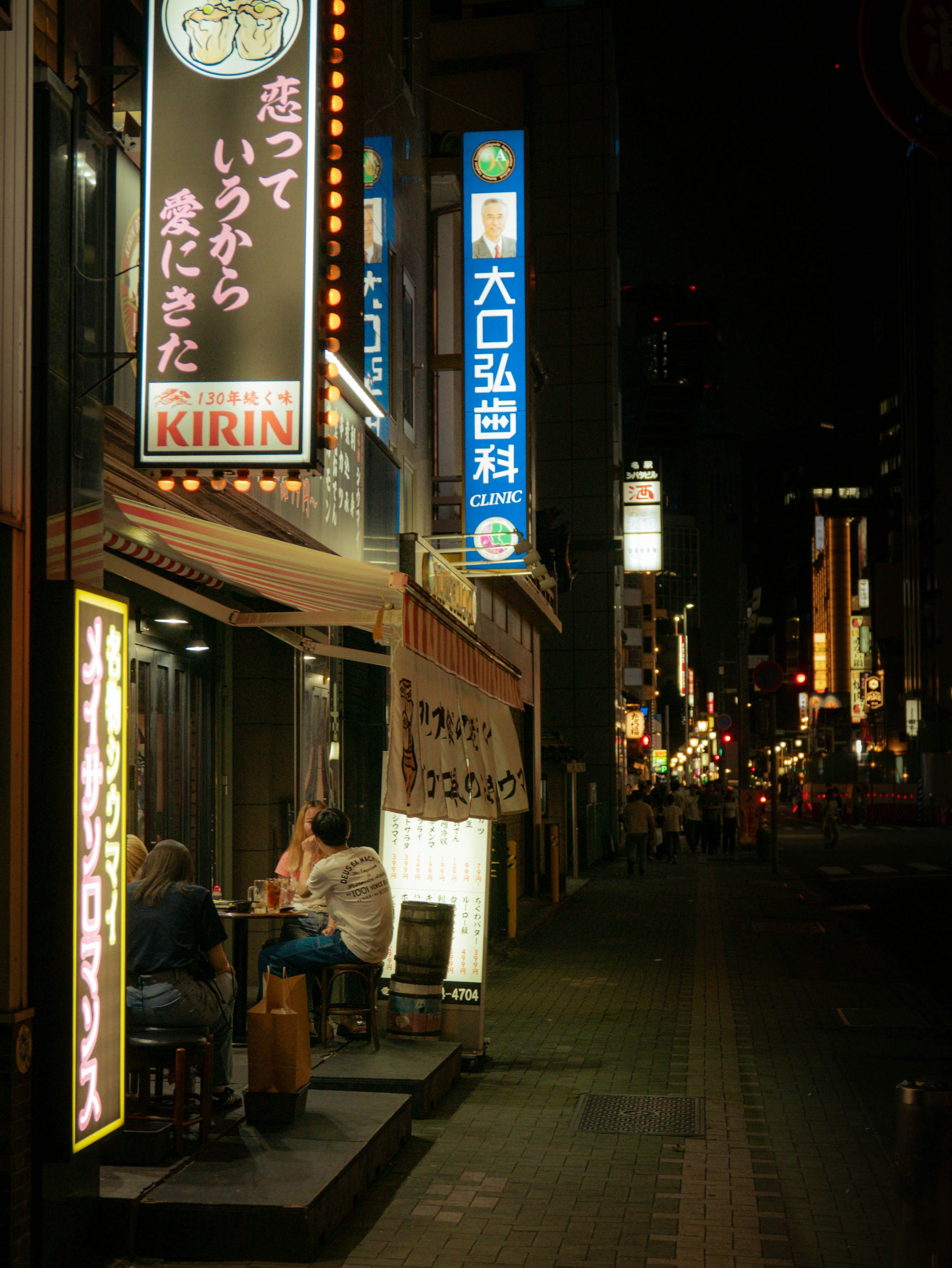 Neon Alley Portrait: A Quiet Moment Beneath the Signs