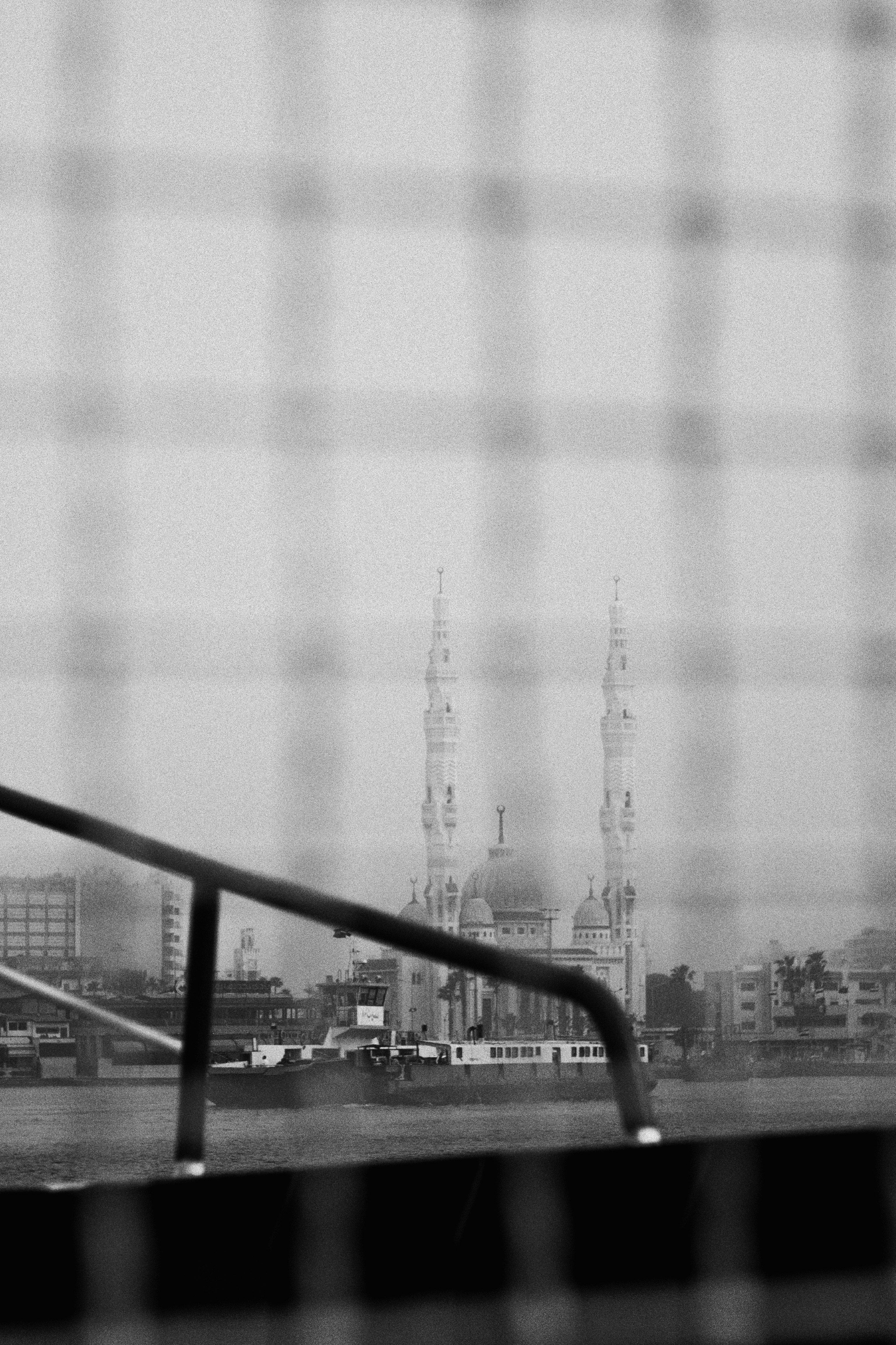 Ghosts of the Glass City: Mosque Towers Through a Gridded Veil