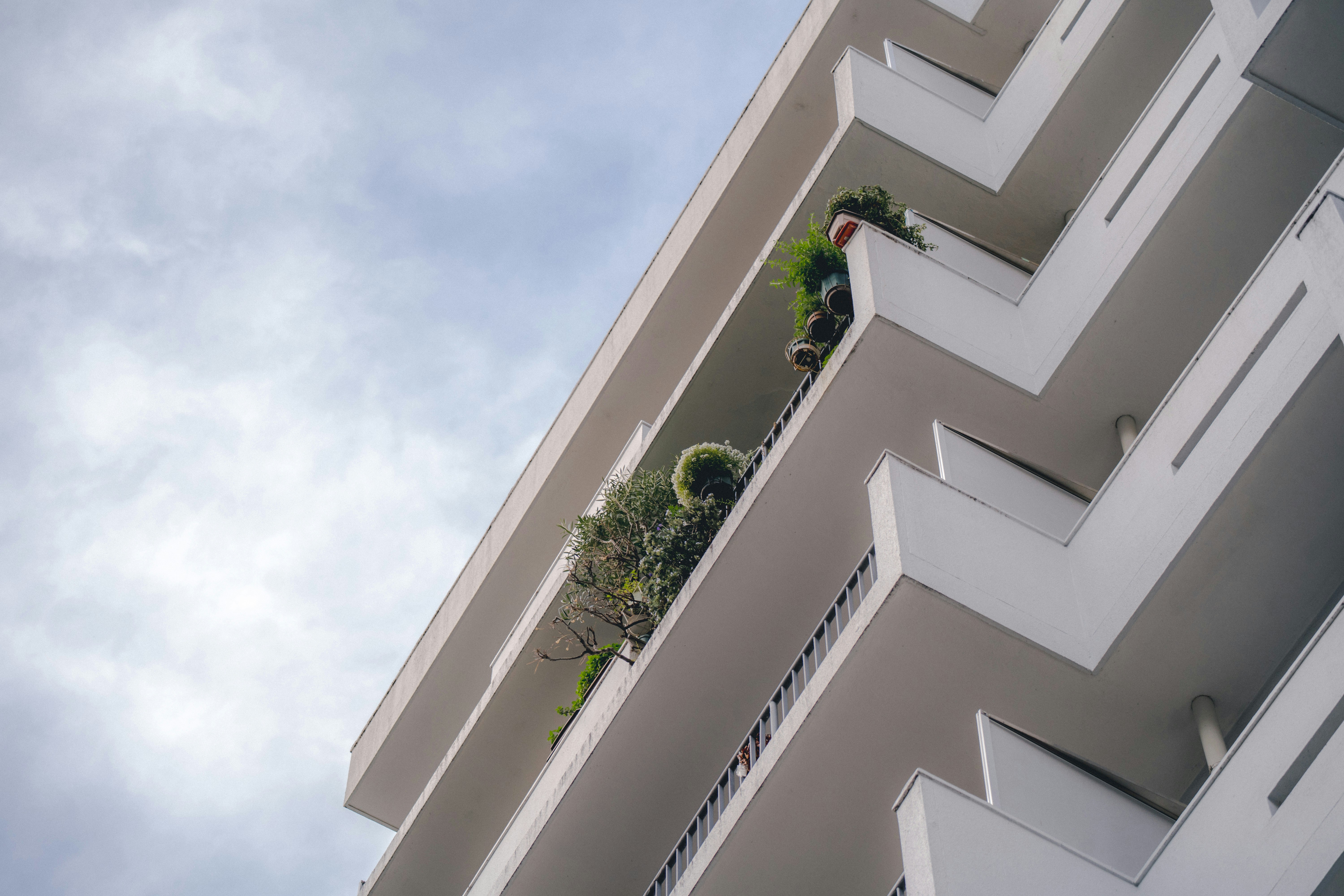 Geometric Balance: Angular Apartment Facade Against a Sky