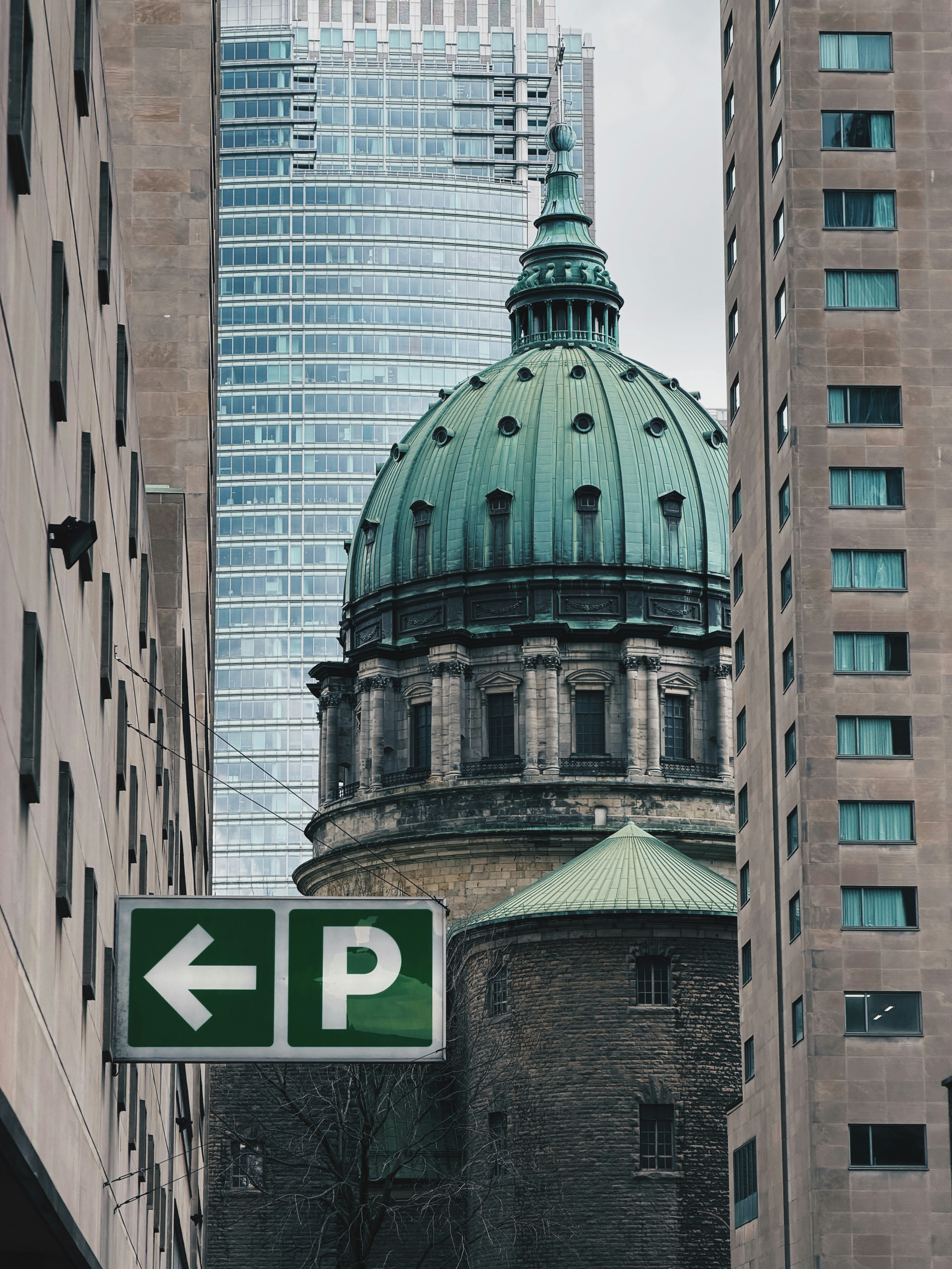 City Dome Amid Skyscrapers: A Historic Roof Surrounded by Glass Towers