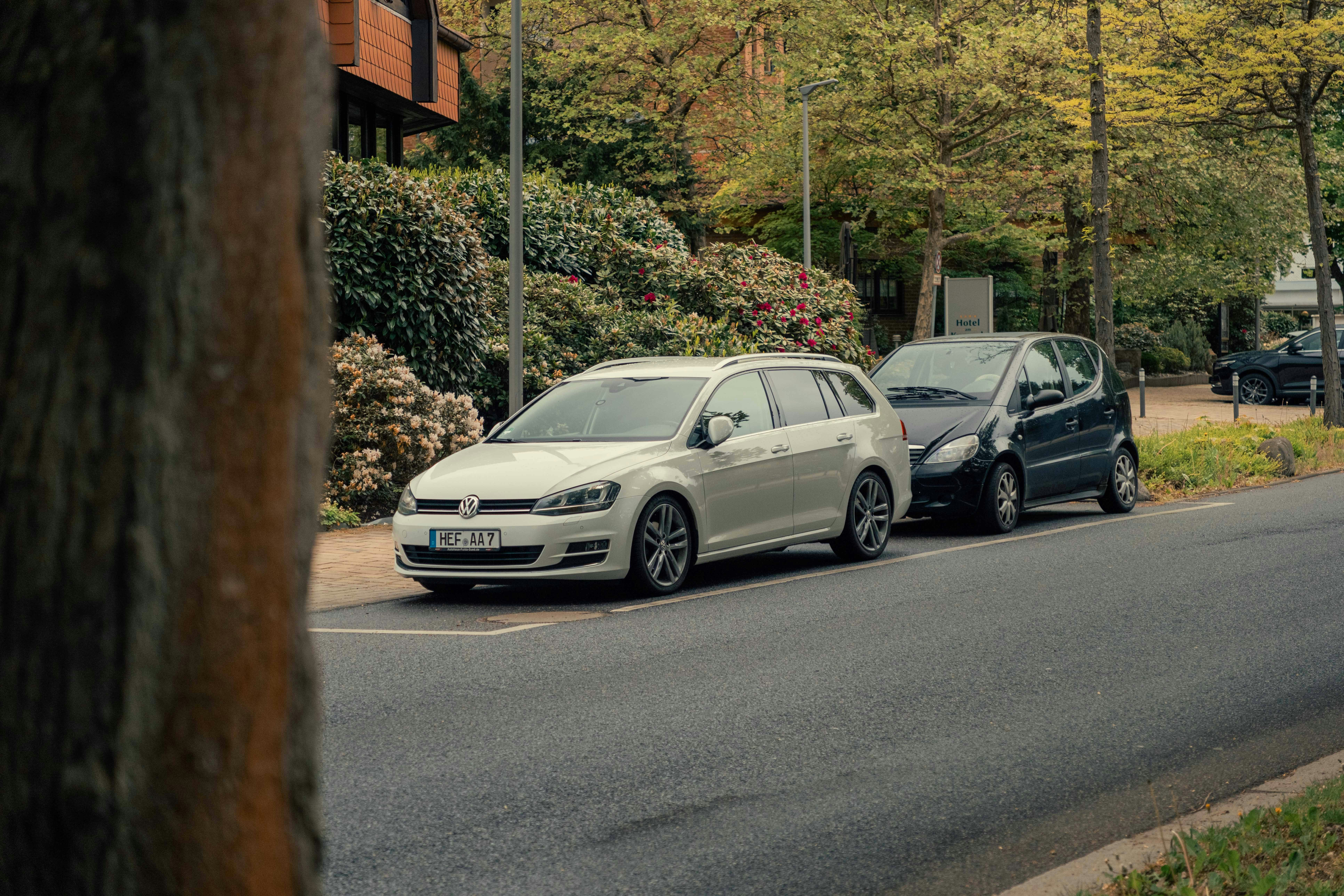 Line of parked cars along a quiet residential street