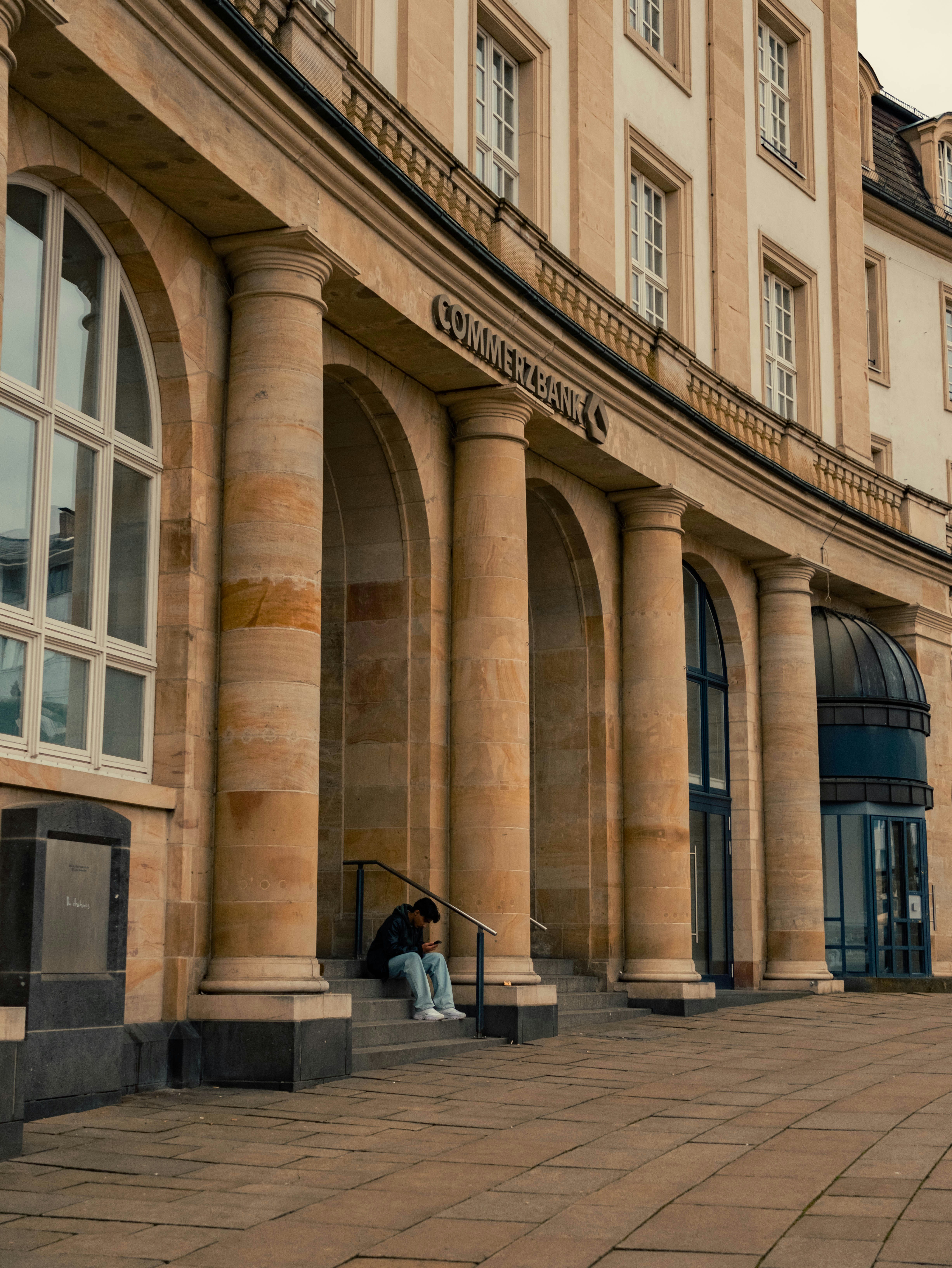 Lonely Bench Beneath Arched Facade