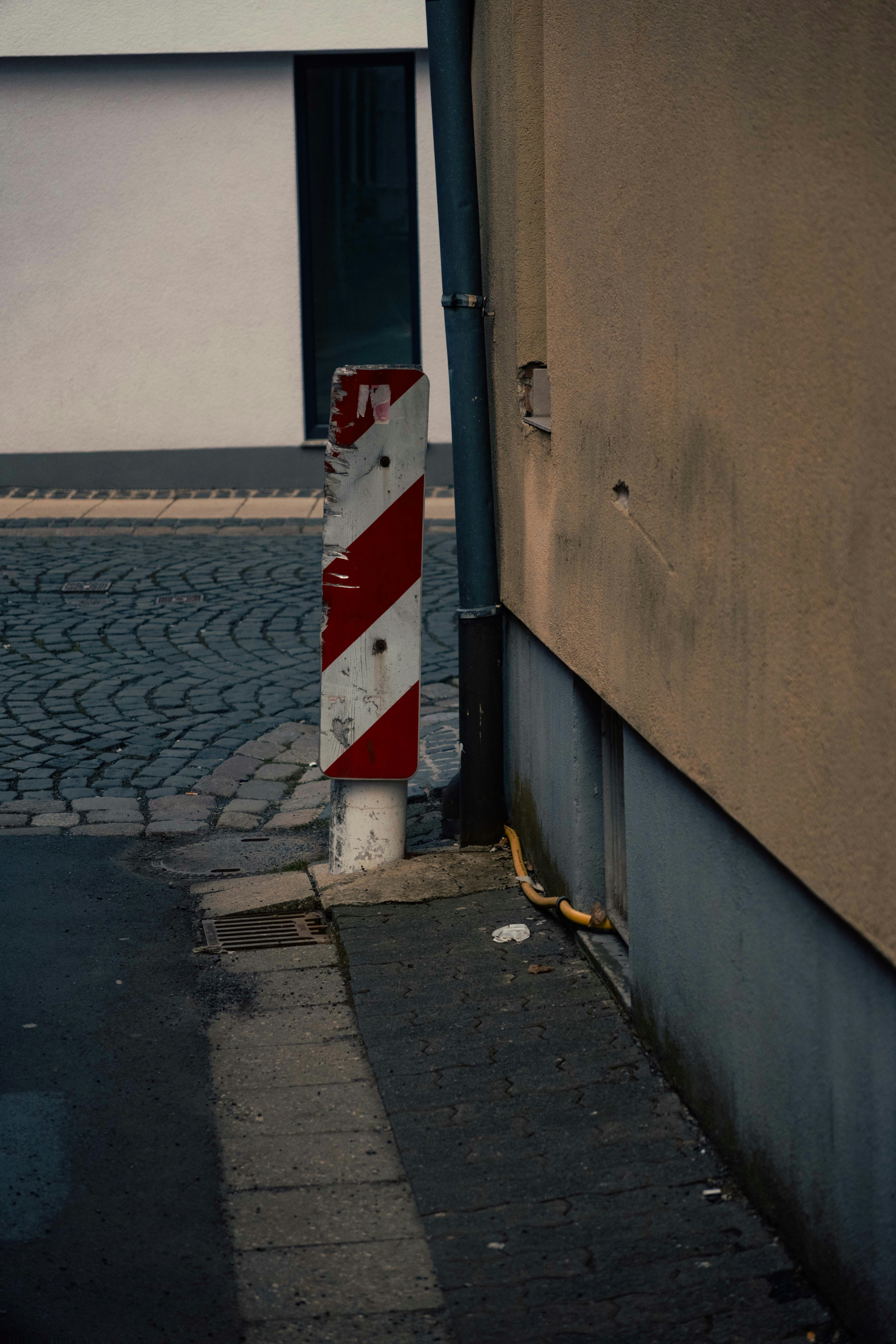 Red-and-White Barrier at the Narrow Alley Edge