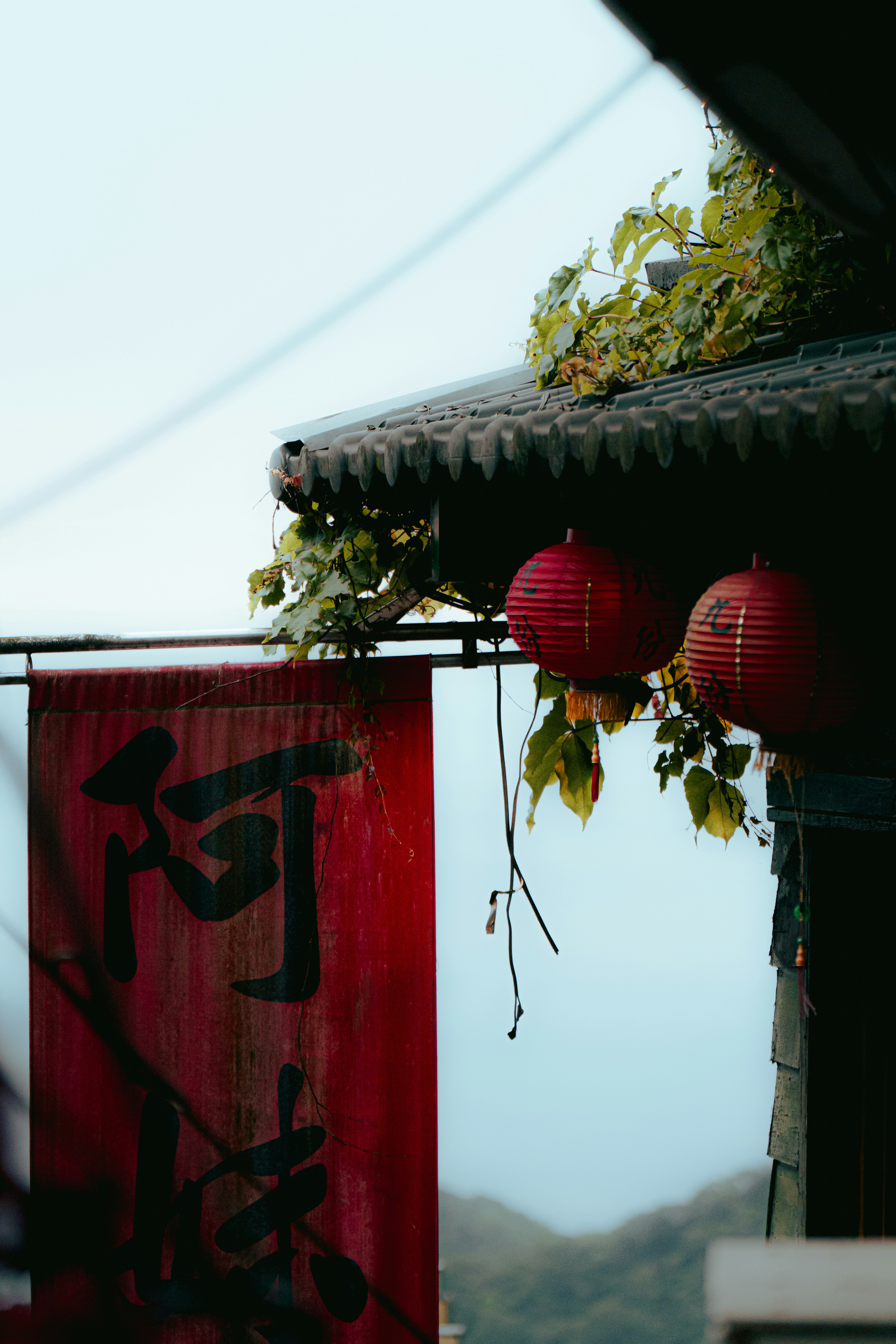 Red Lanterns and Calligraphy Banner Framing a Traditional Corner