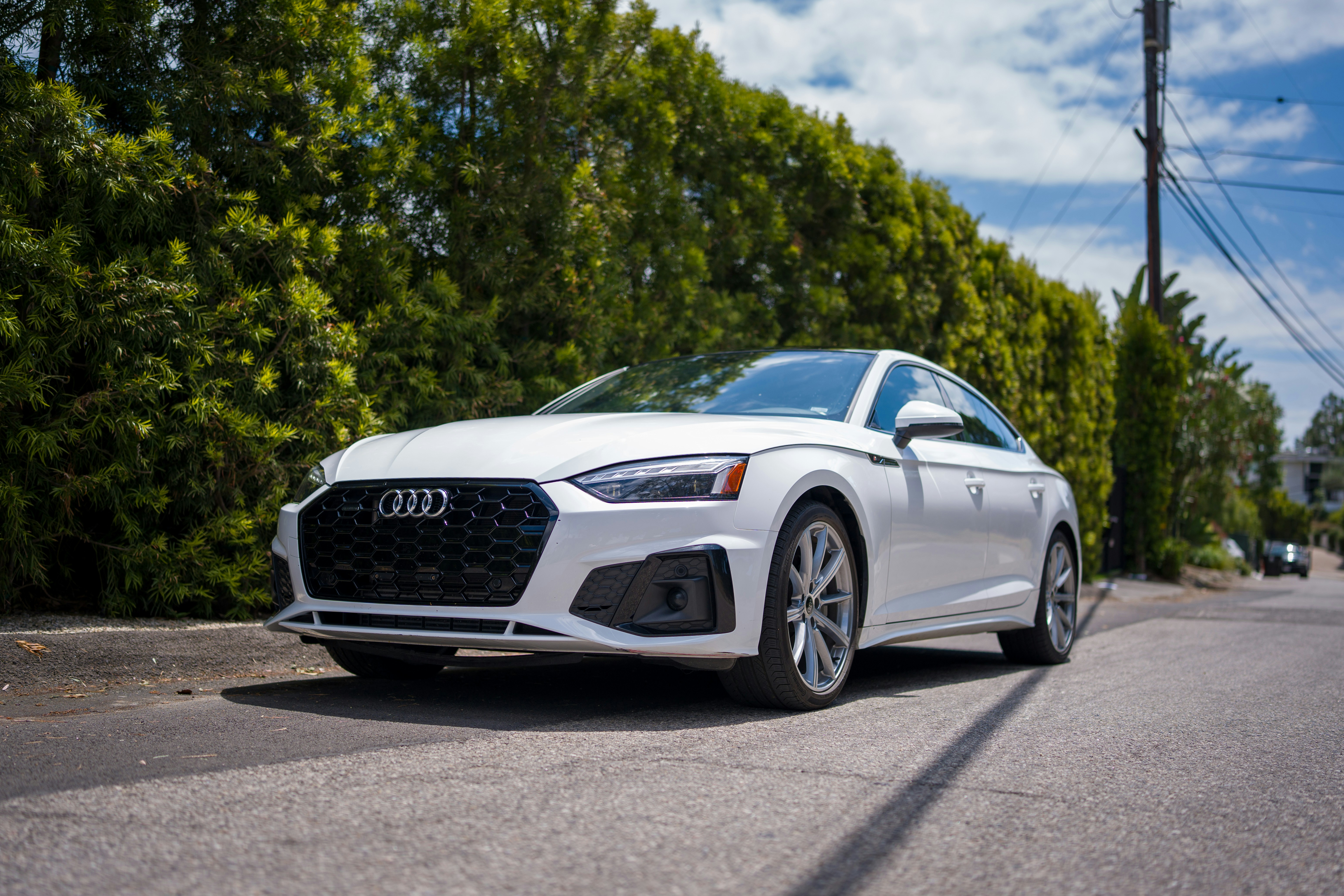 White Audi sedan resting on a sunlit street
