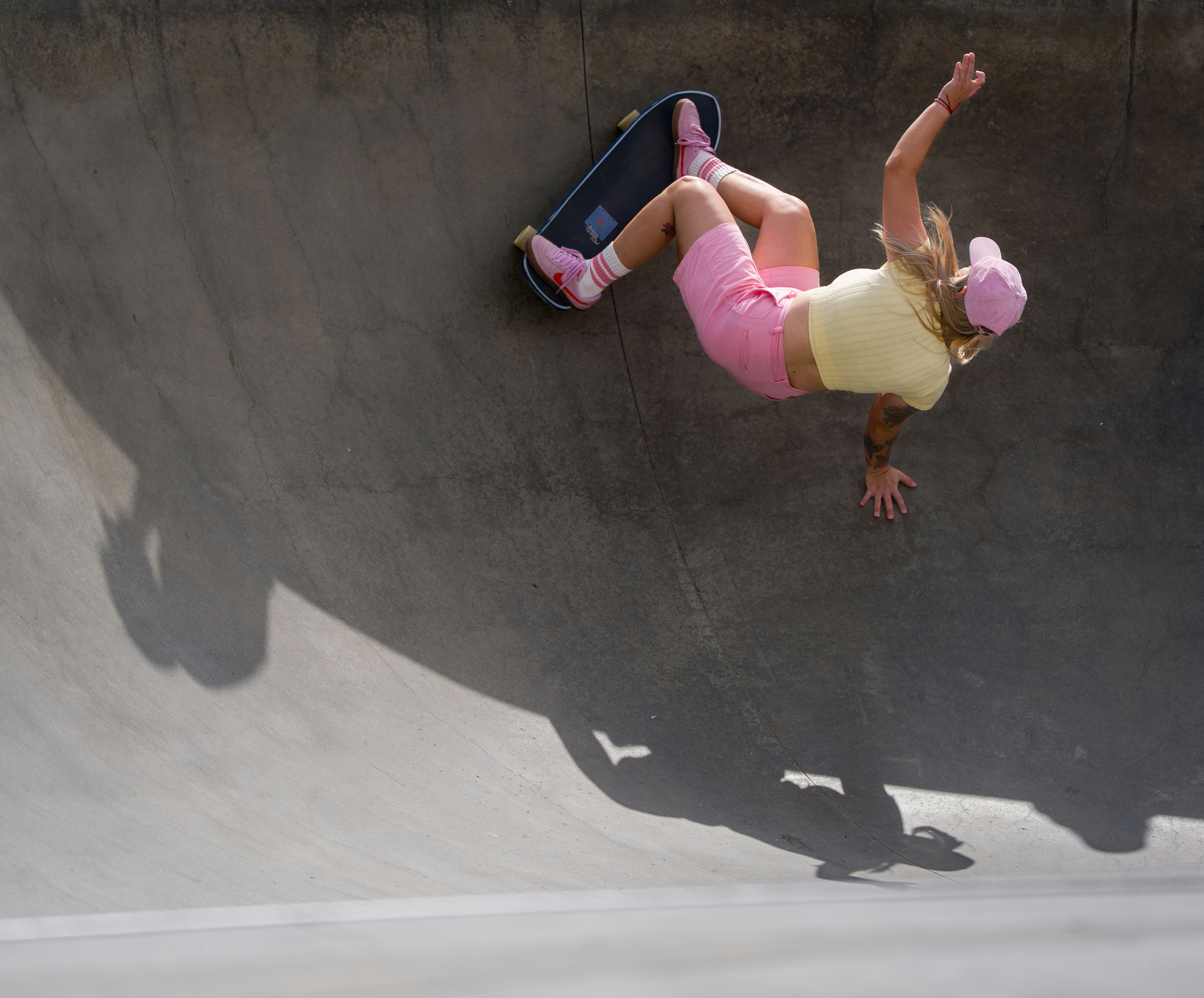 Gravity-Defying Skateboarder: A Sunlit Wall Ride in Motion