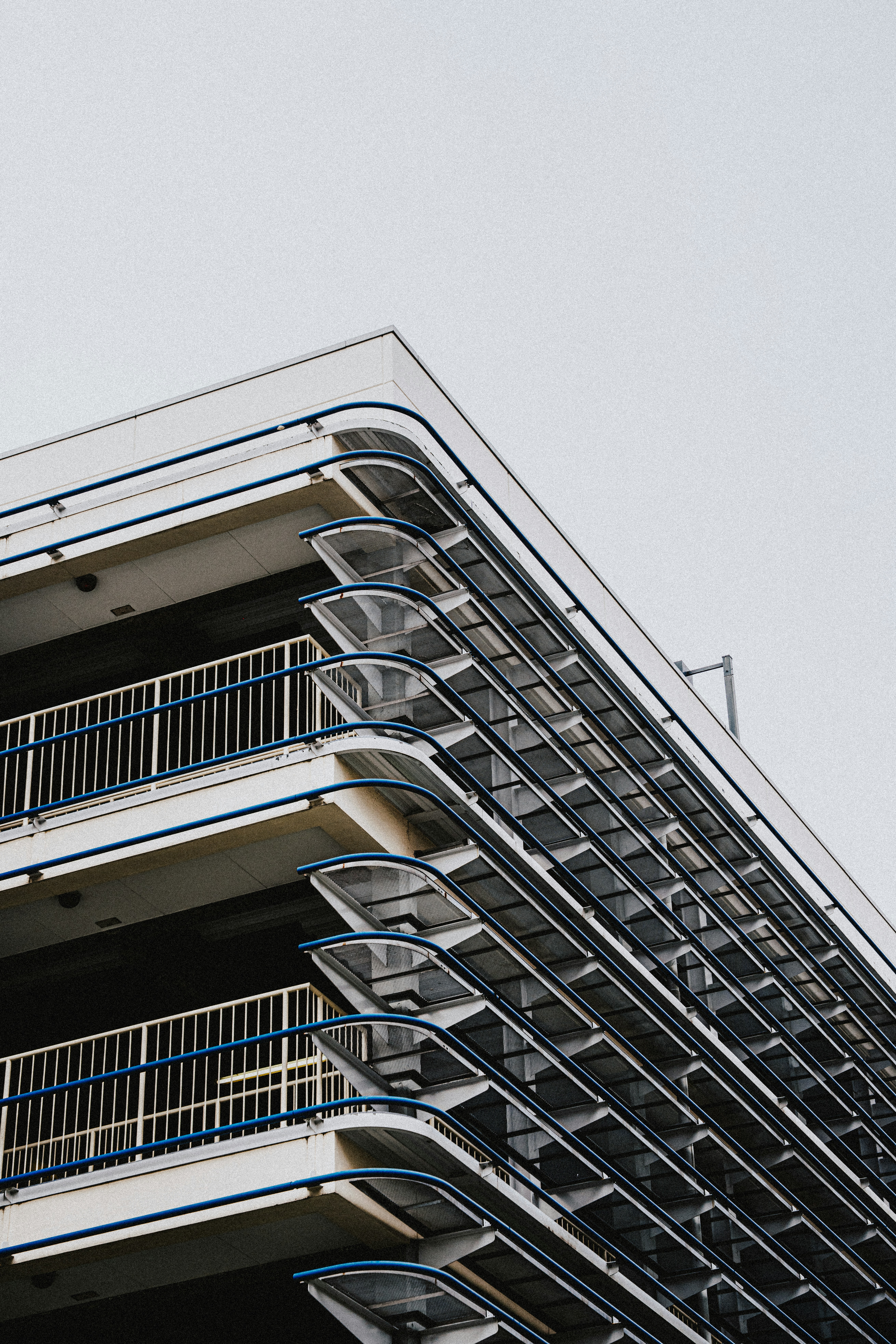 Edge of Ascent: A Close-up of Layered Curves on a Modern Parking Structure