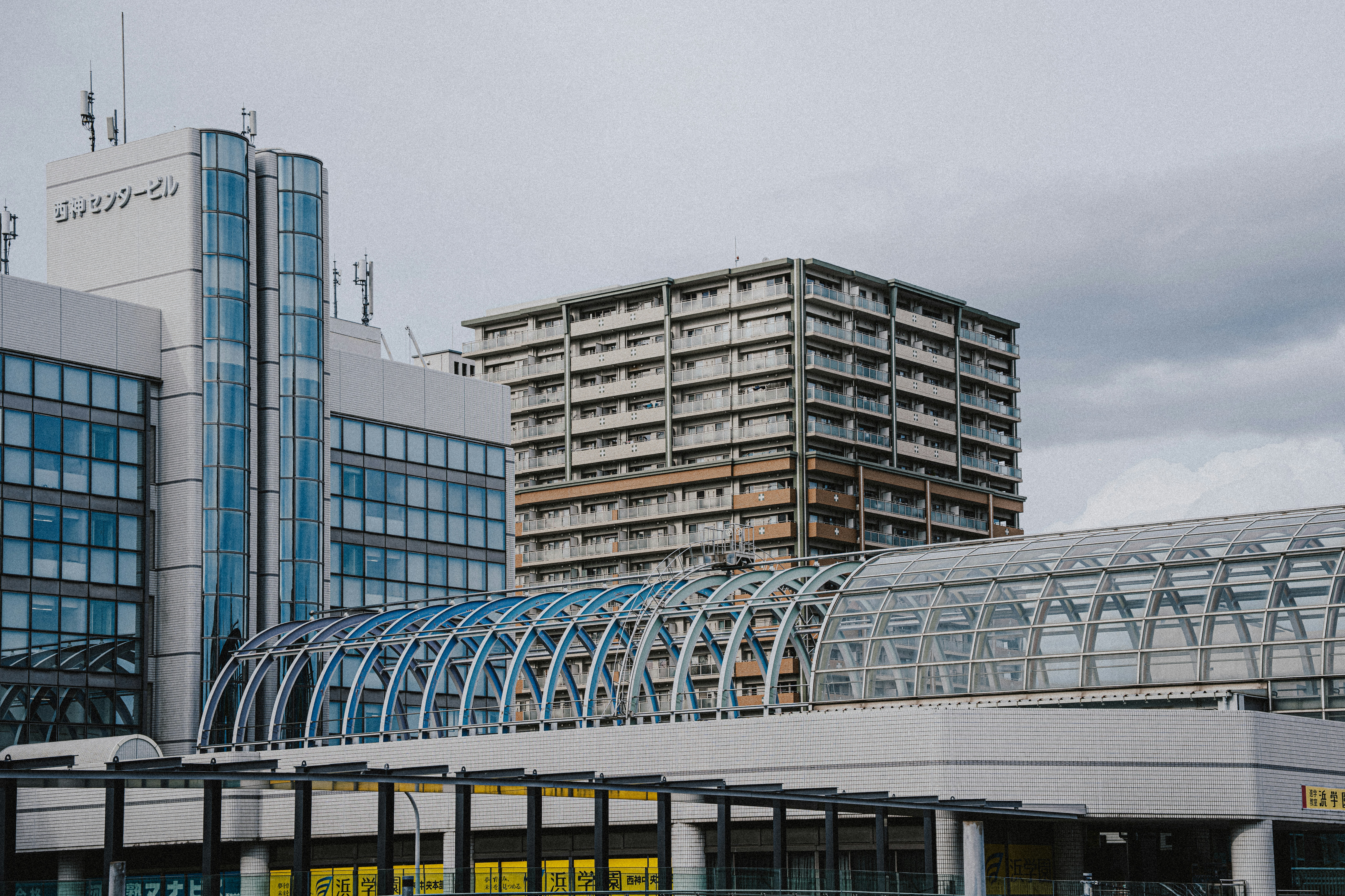 Glass Arcades Over a Stacked Cityscape