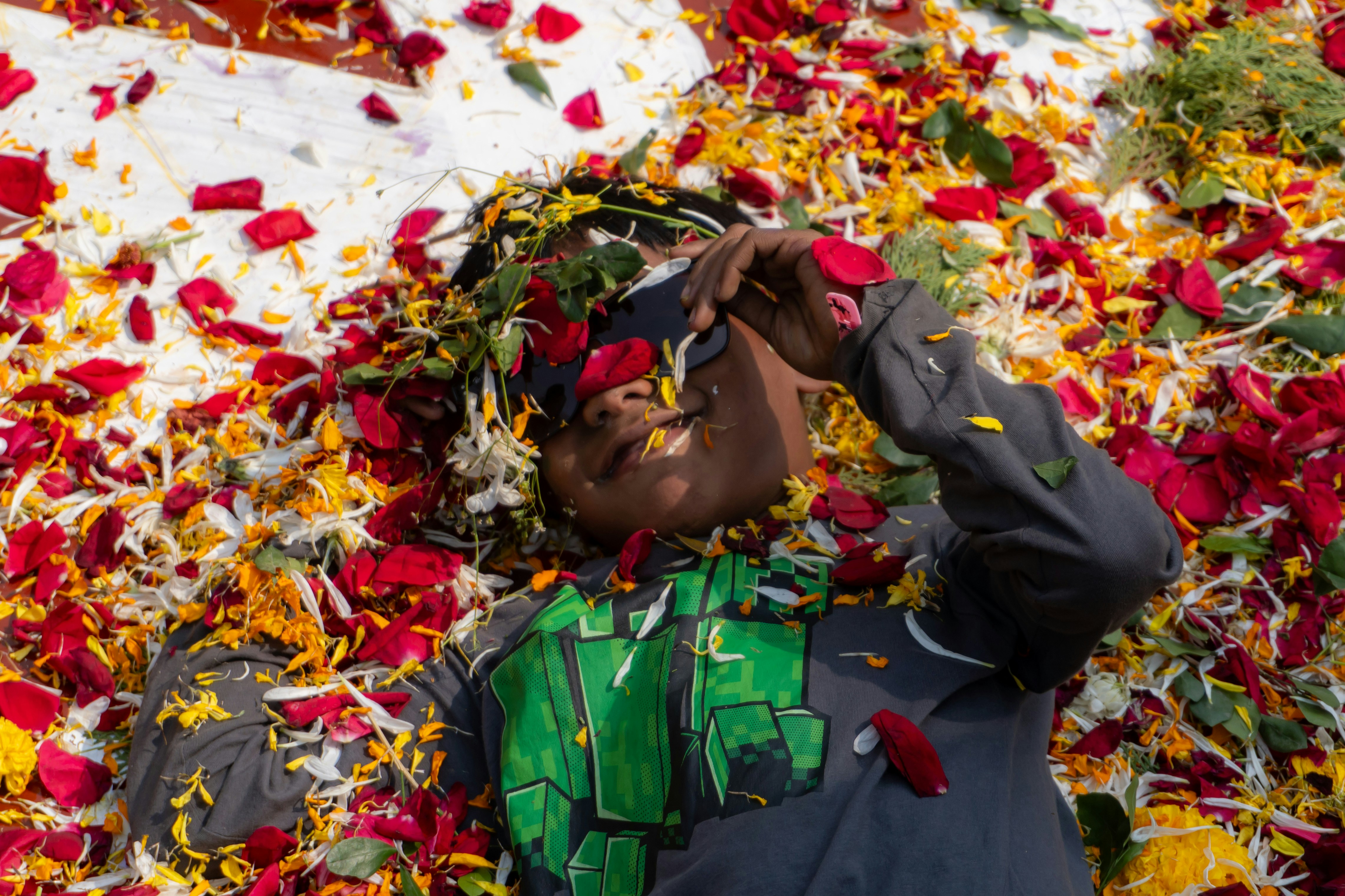 Burst of petals: a child beneath a confetti rain