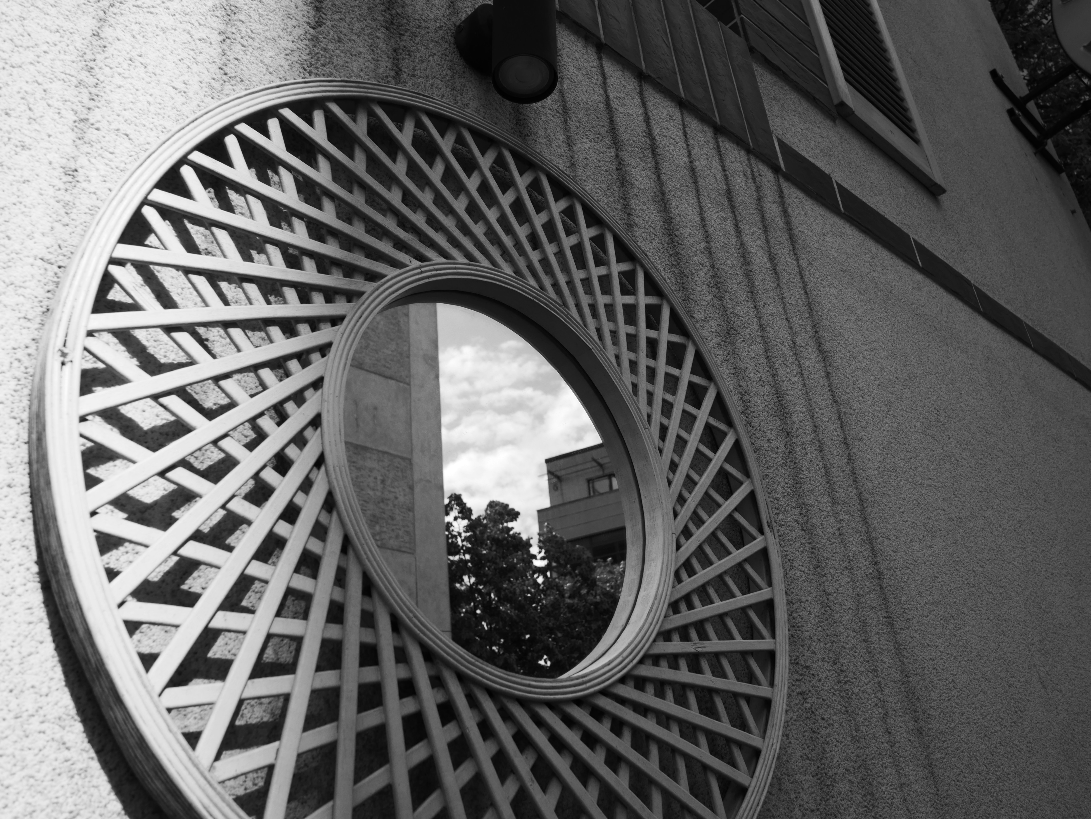 Circular Sunburst Gate: A Black-and-White Facade Framing Skyward
