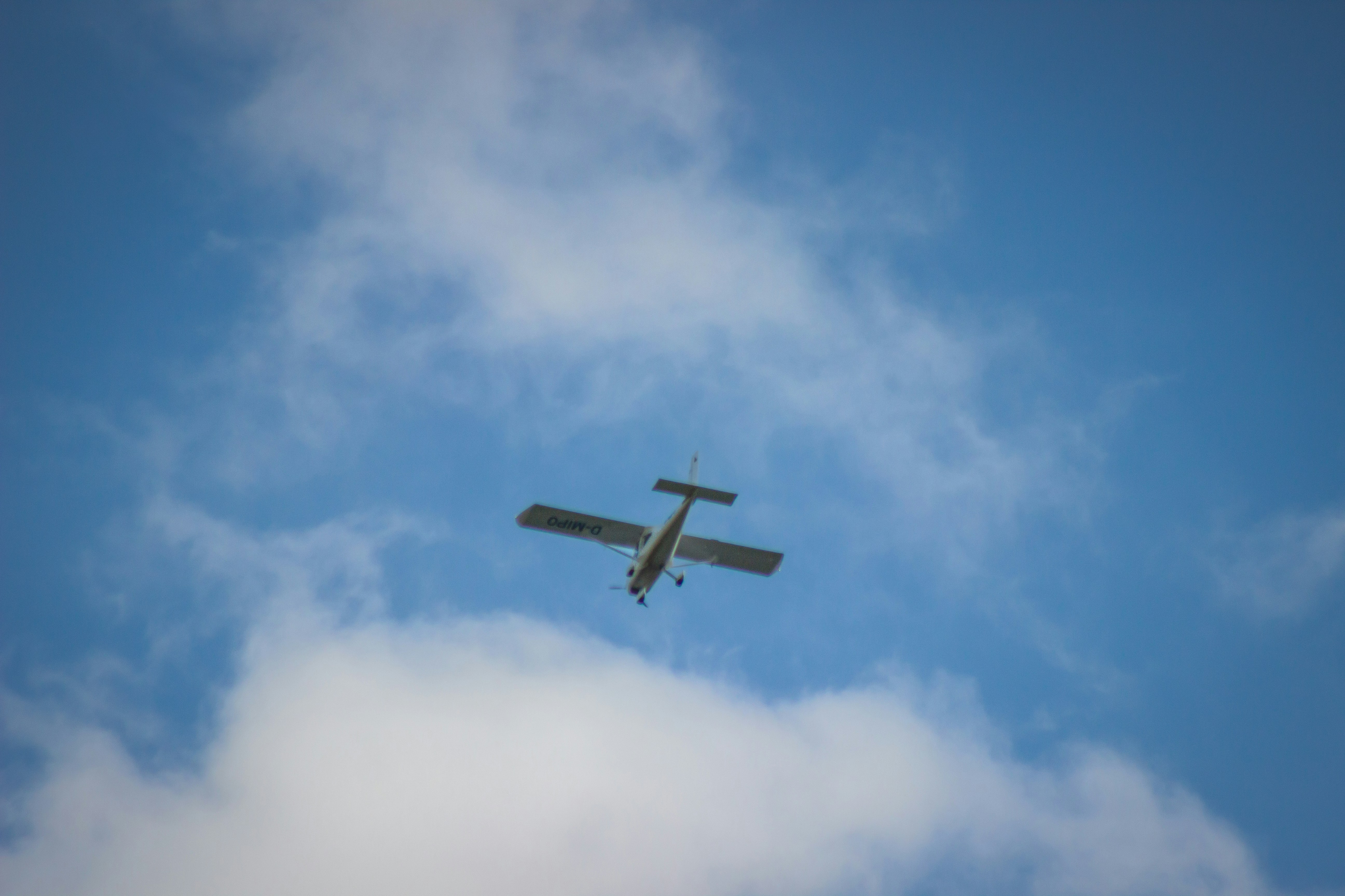 Soaring Single-Engine: A Lone Plane Cuts Through Blue