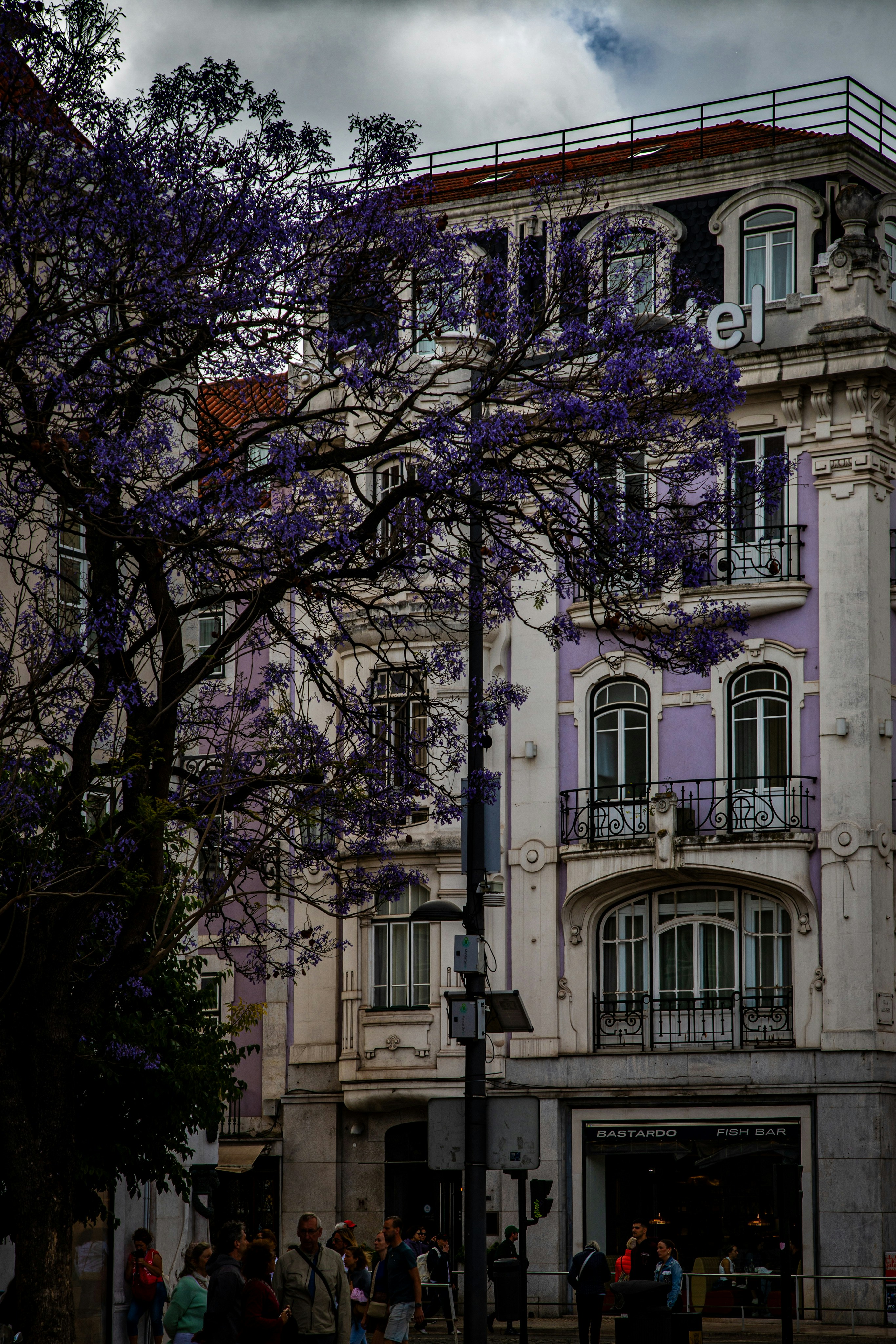 Lavender Facade and Crescent Shadows on a Corner European Hotel