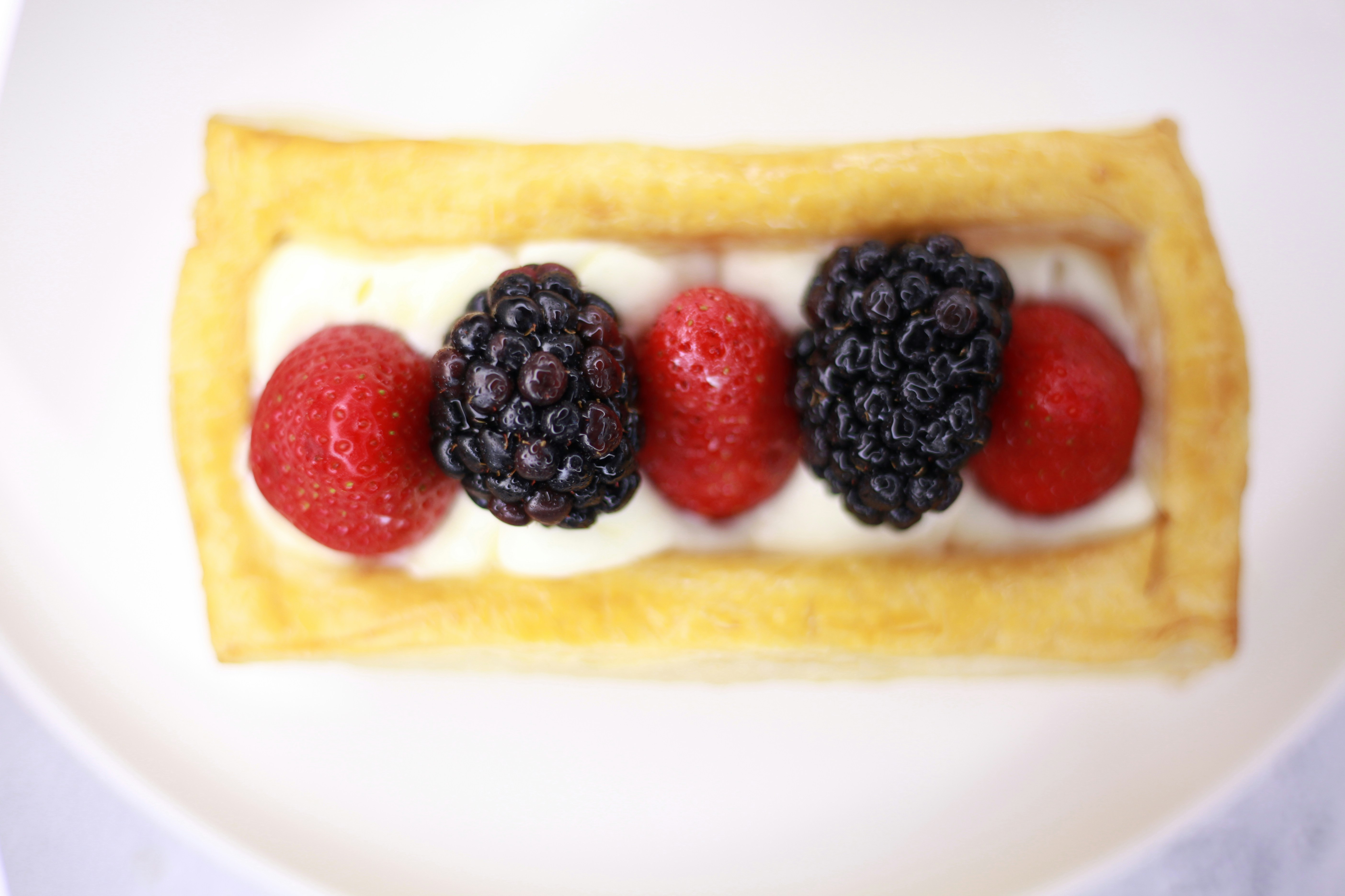 Berry-filled Puff Pastry Tower on Cream Bed