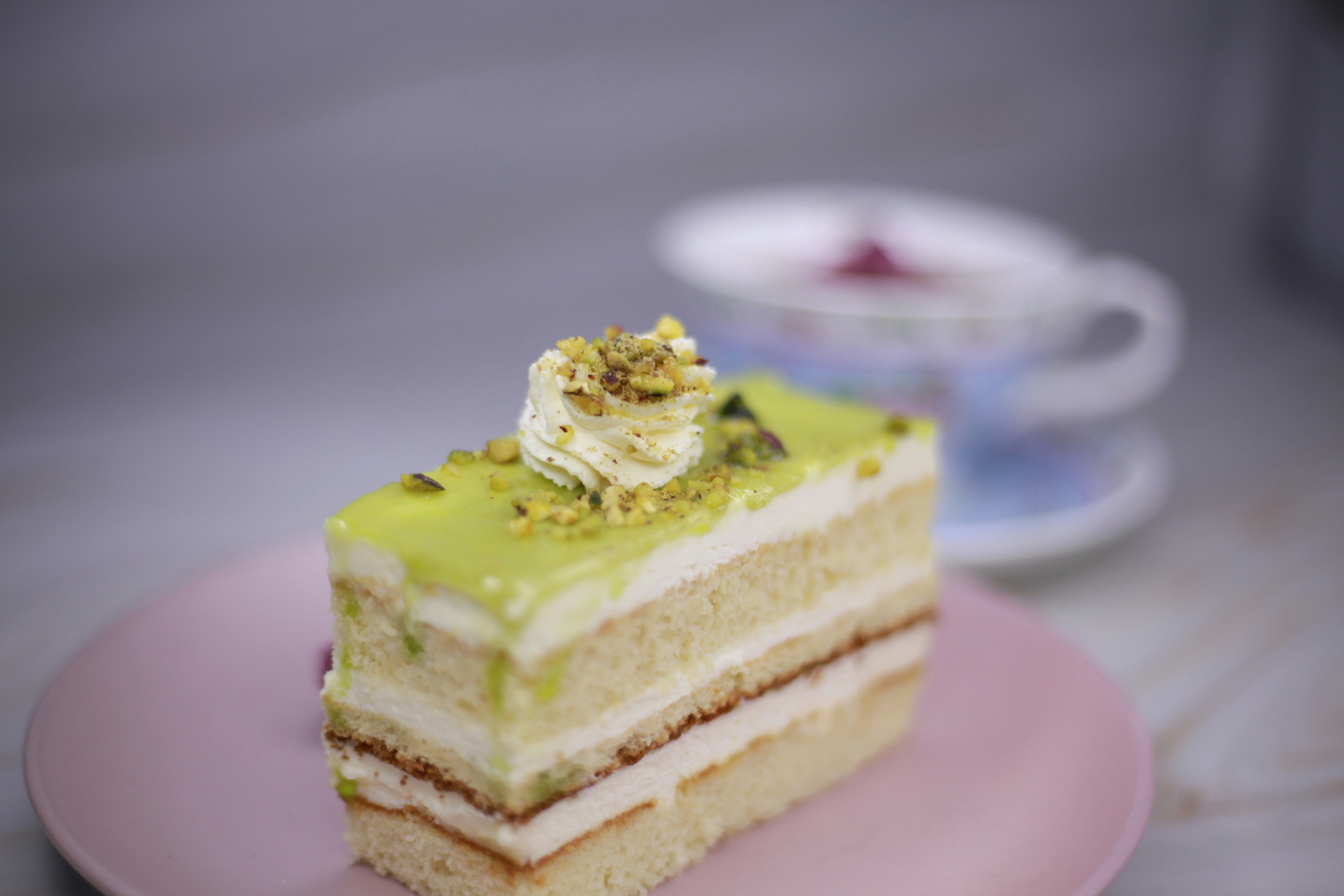 Green-Glazed Delight: A Slice of Pistachio-Topped Cake