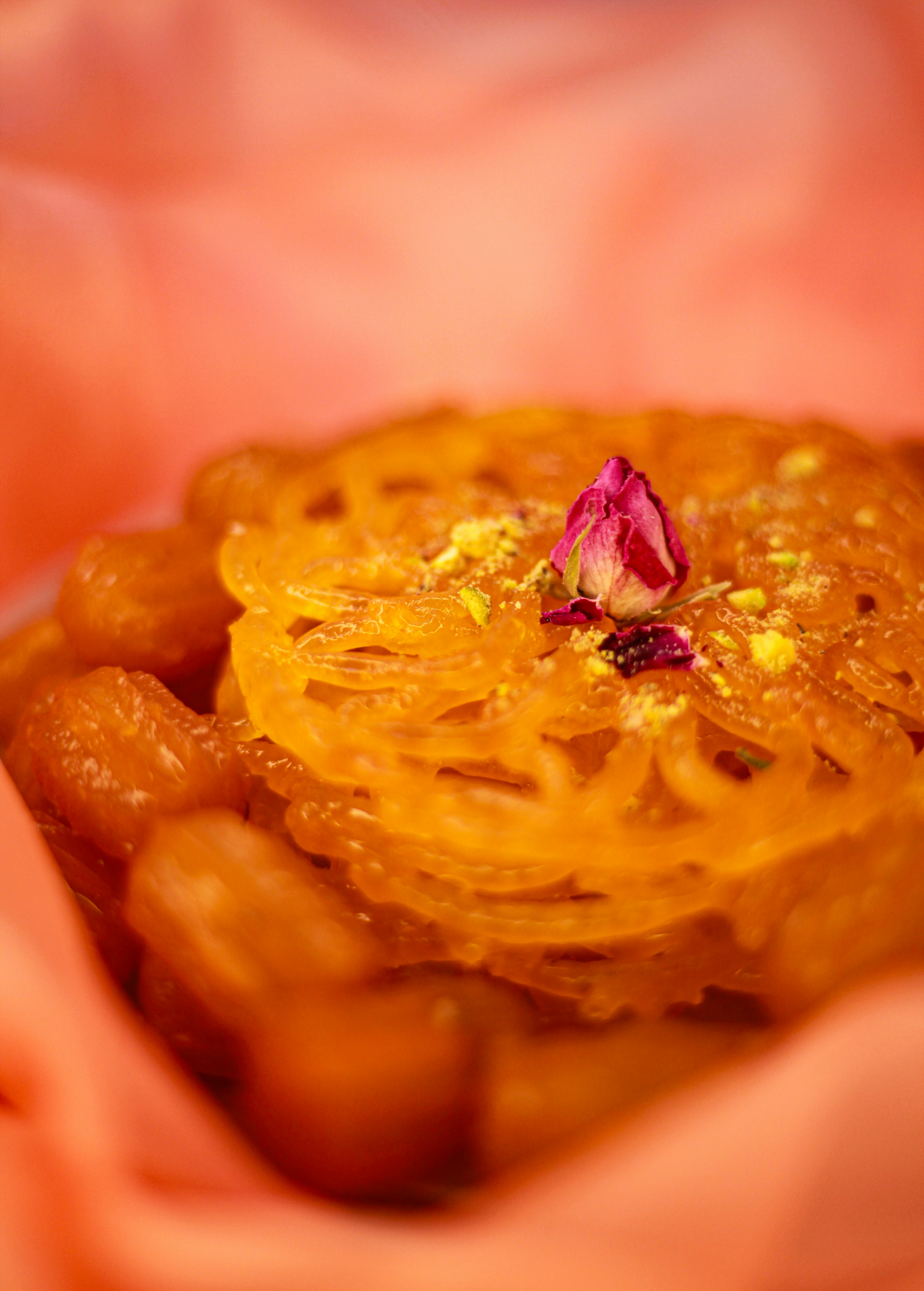 Glowing Orange Lotus: a close-up of a decorative sweet in a soft pink wrap