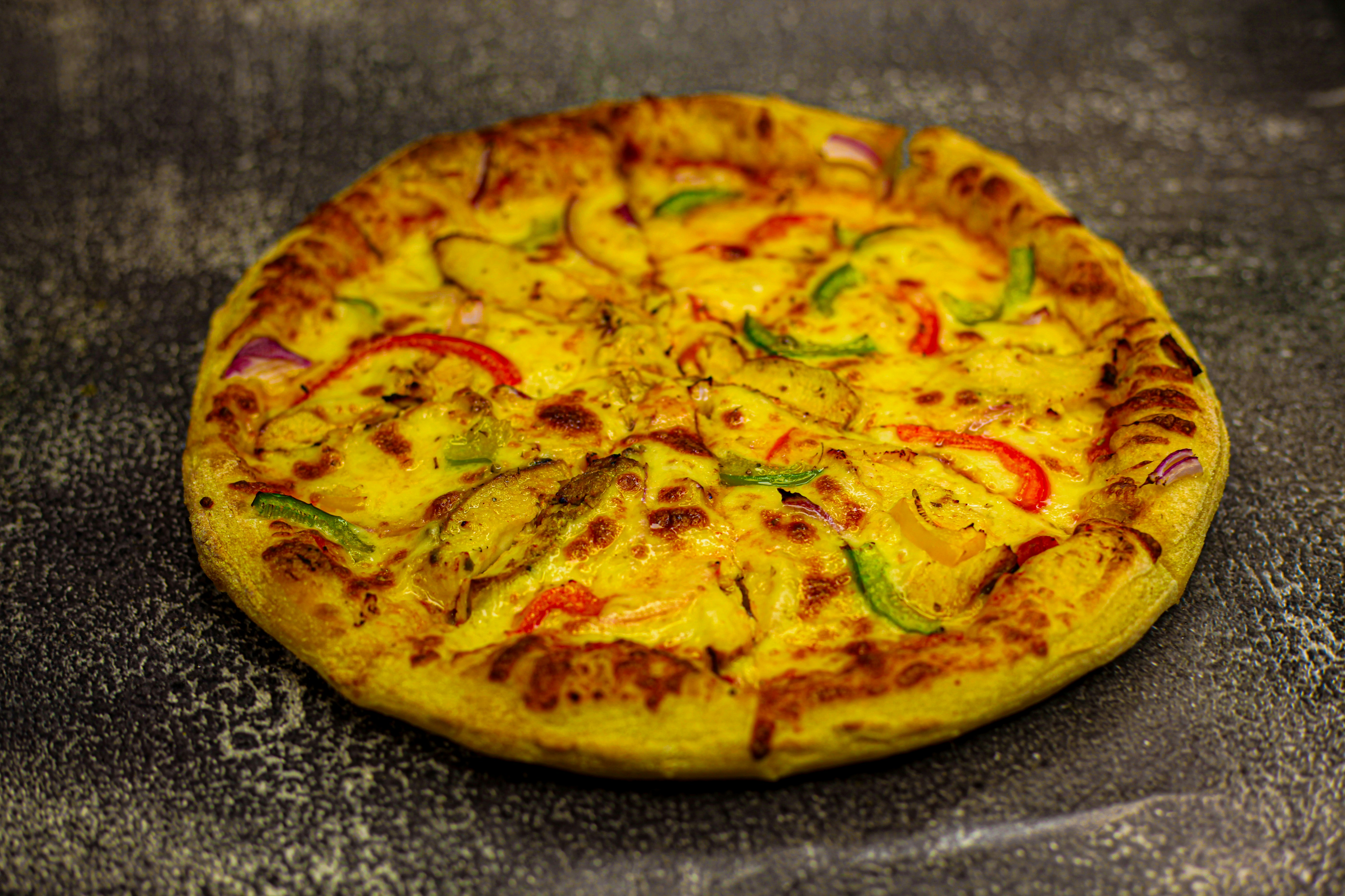 Golden Circular Pizza on a Dusty Slate