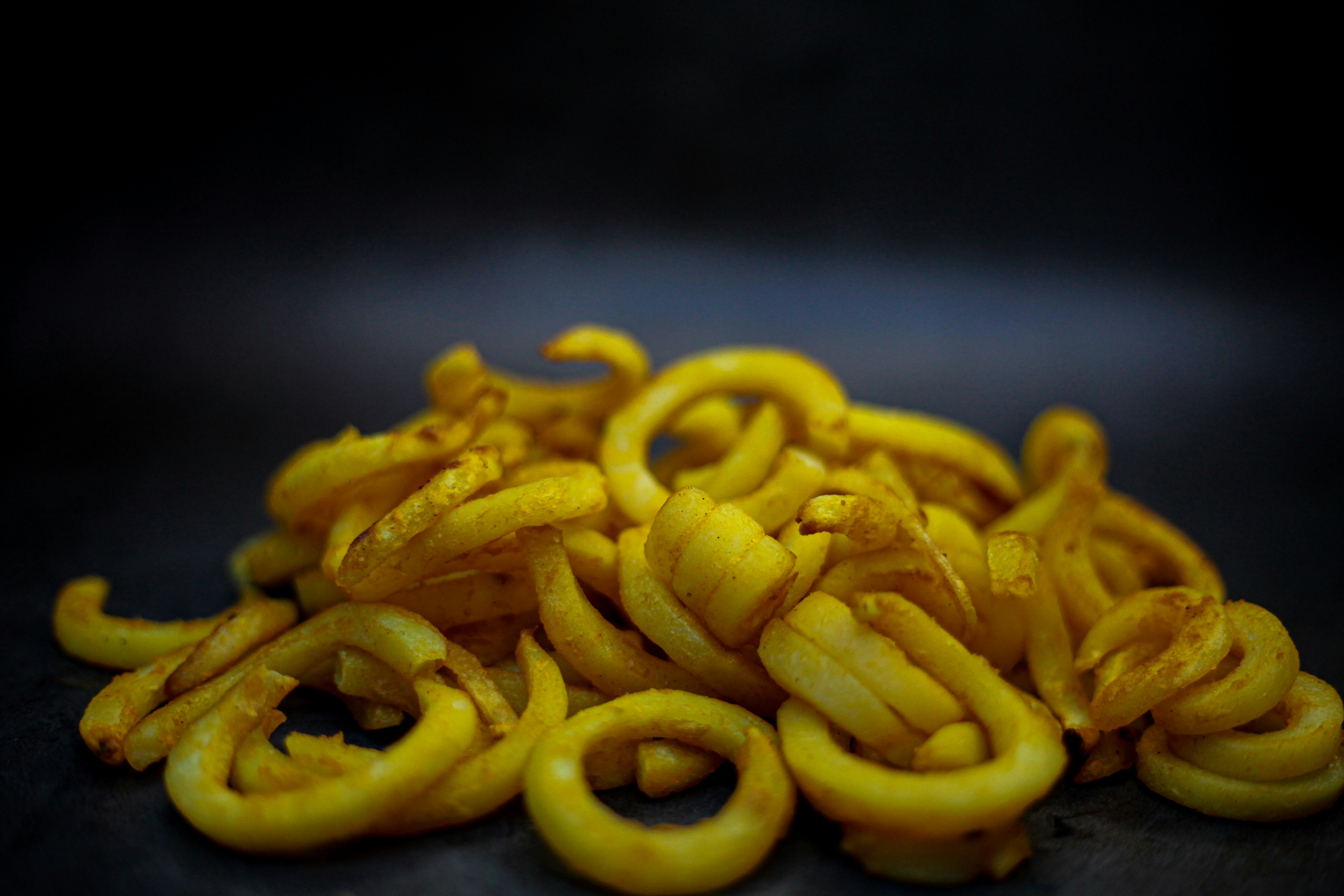 Golden Curled Snack Nest on a Dark Canvas