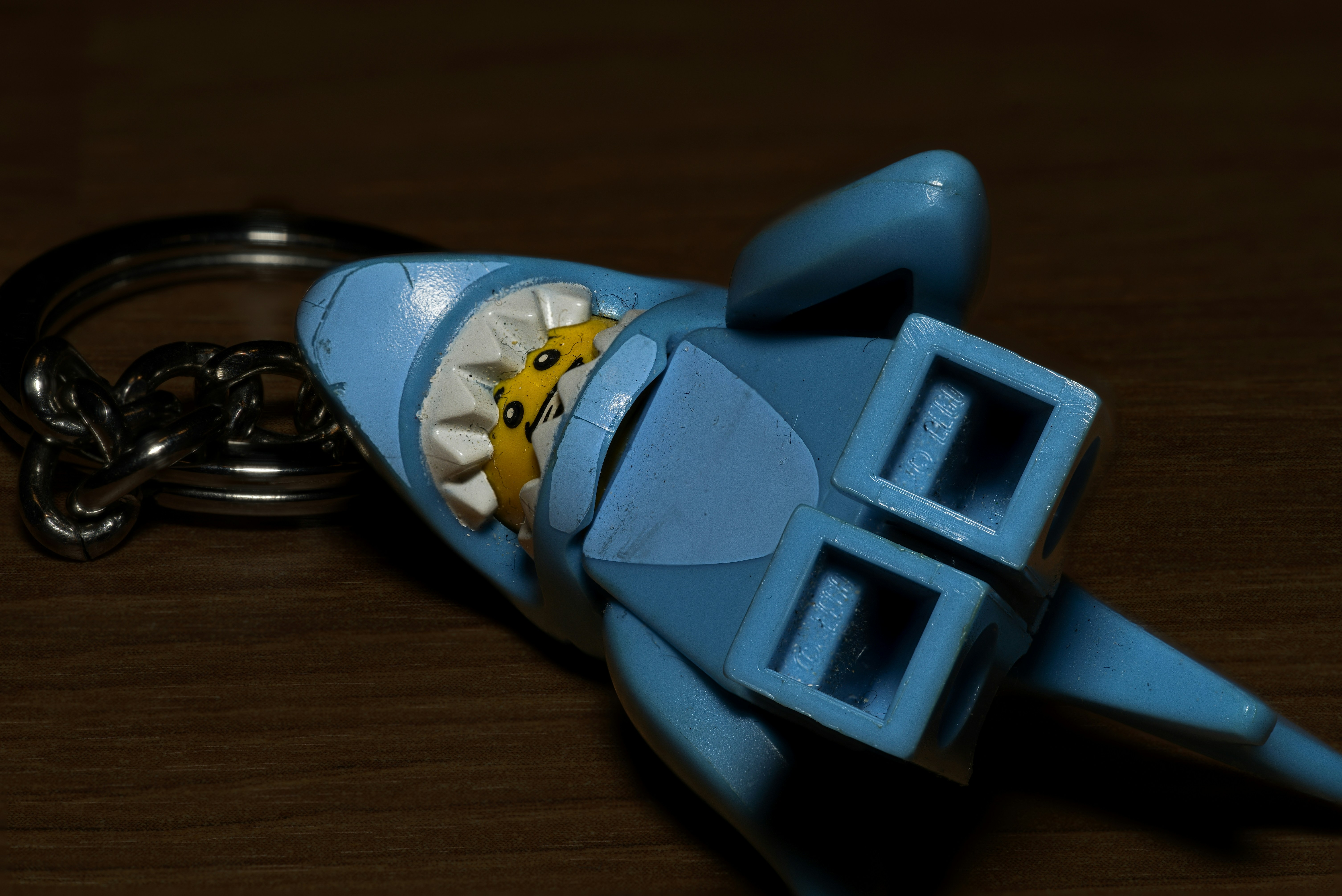 Blue Micro Jet: A Tiny Toy Fighter on a Wooden Runway