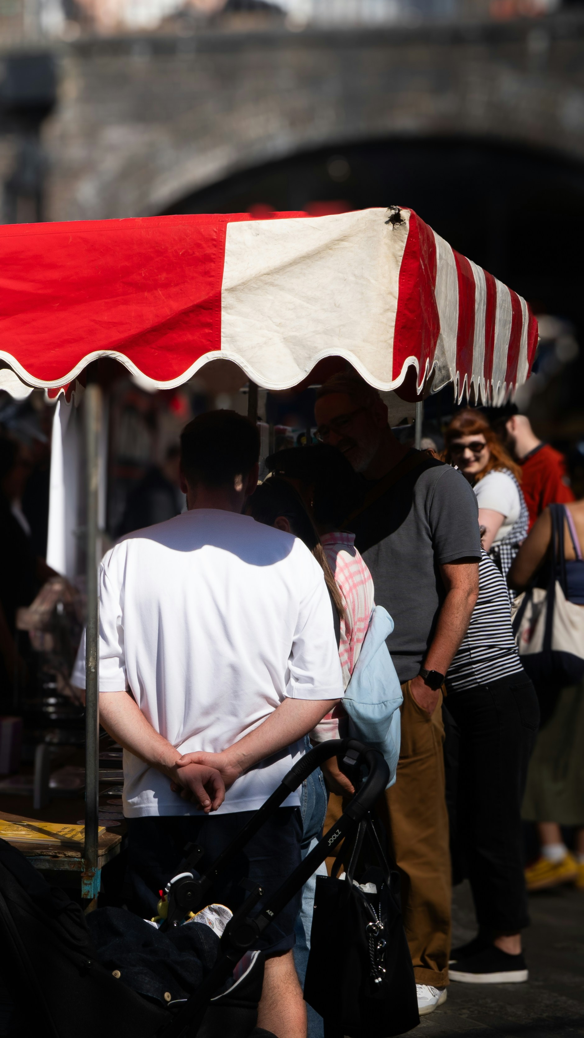 Under the Red and White Canopy: A Crowded Market Moment