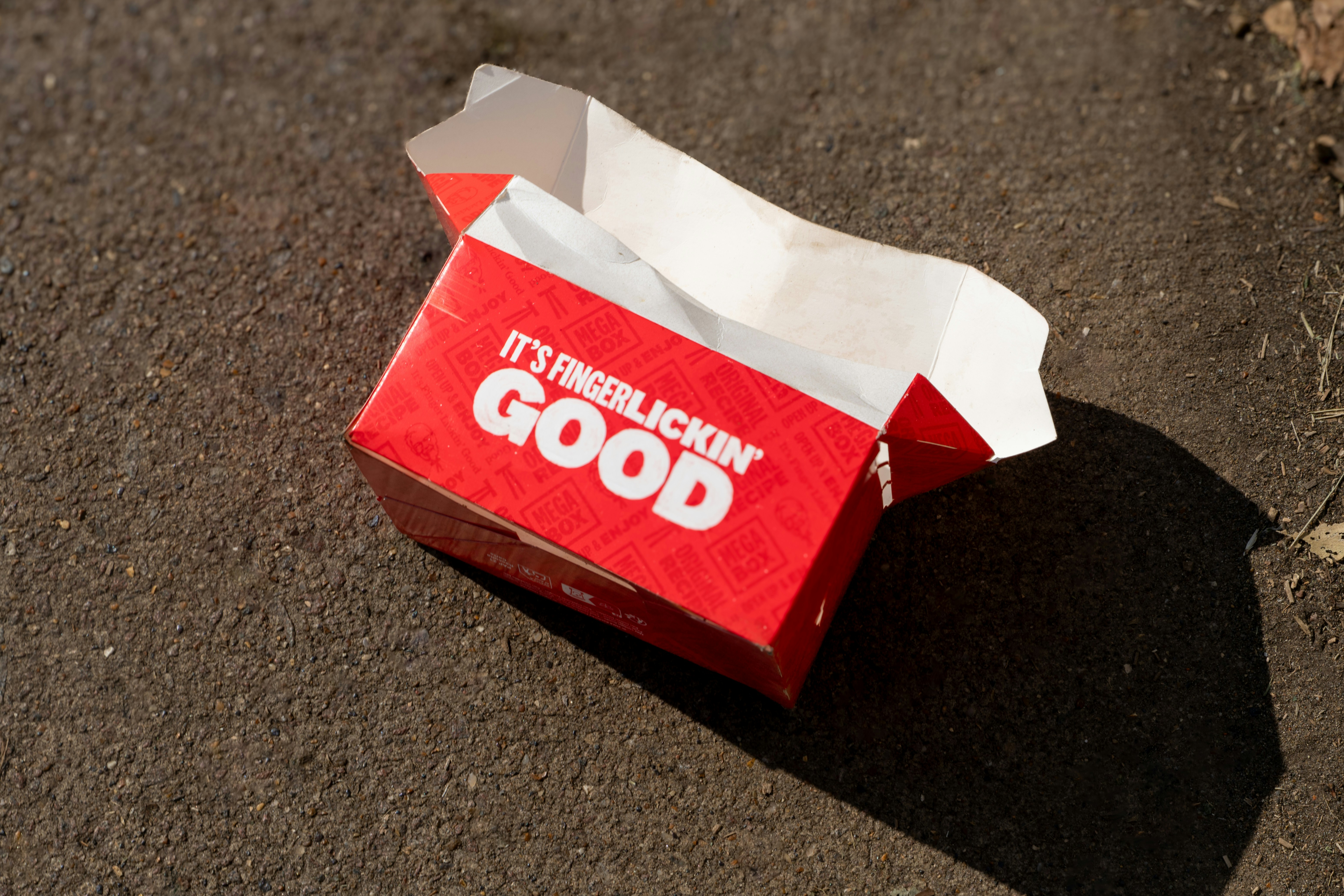 Opened Snack Box on Asphalt: A Quick Moment of Everyday Snackdrama