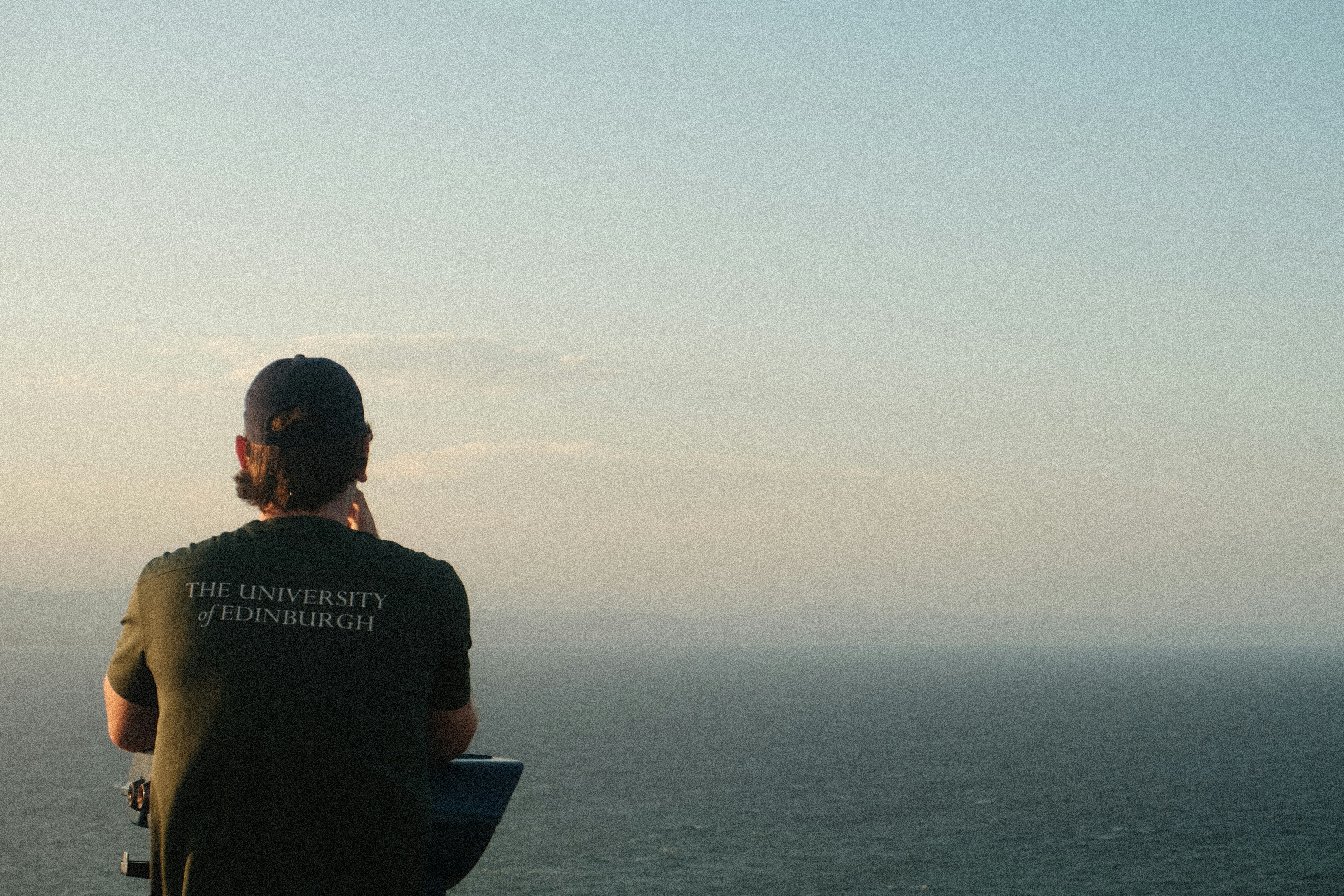 Rooftop Observer: A Quiet Moment Over the Sea