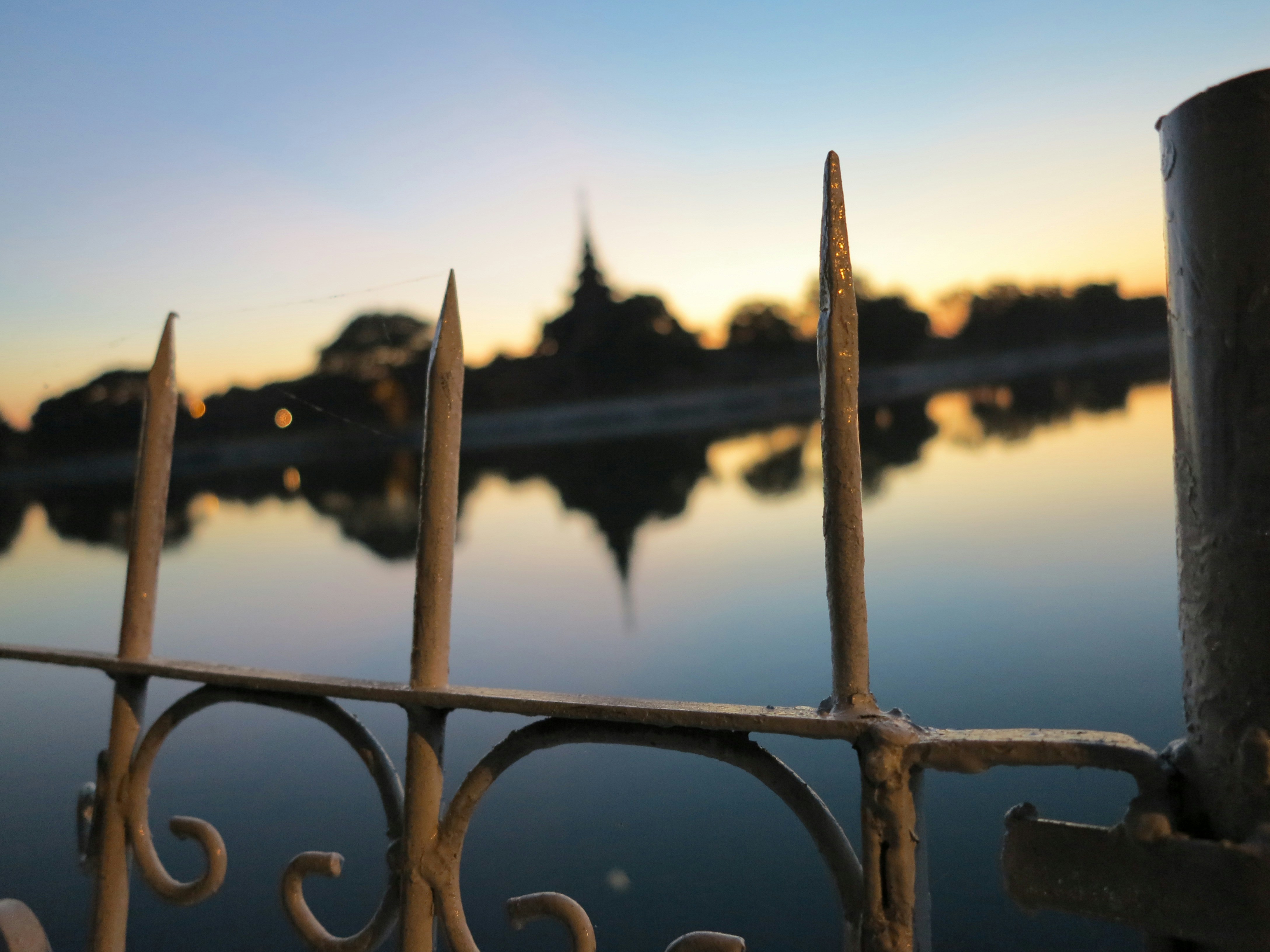 Sunset Reverie Behind Rustic Spikes