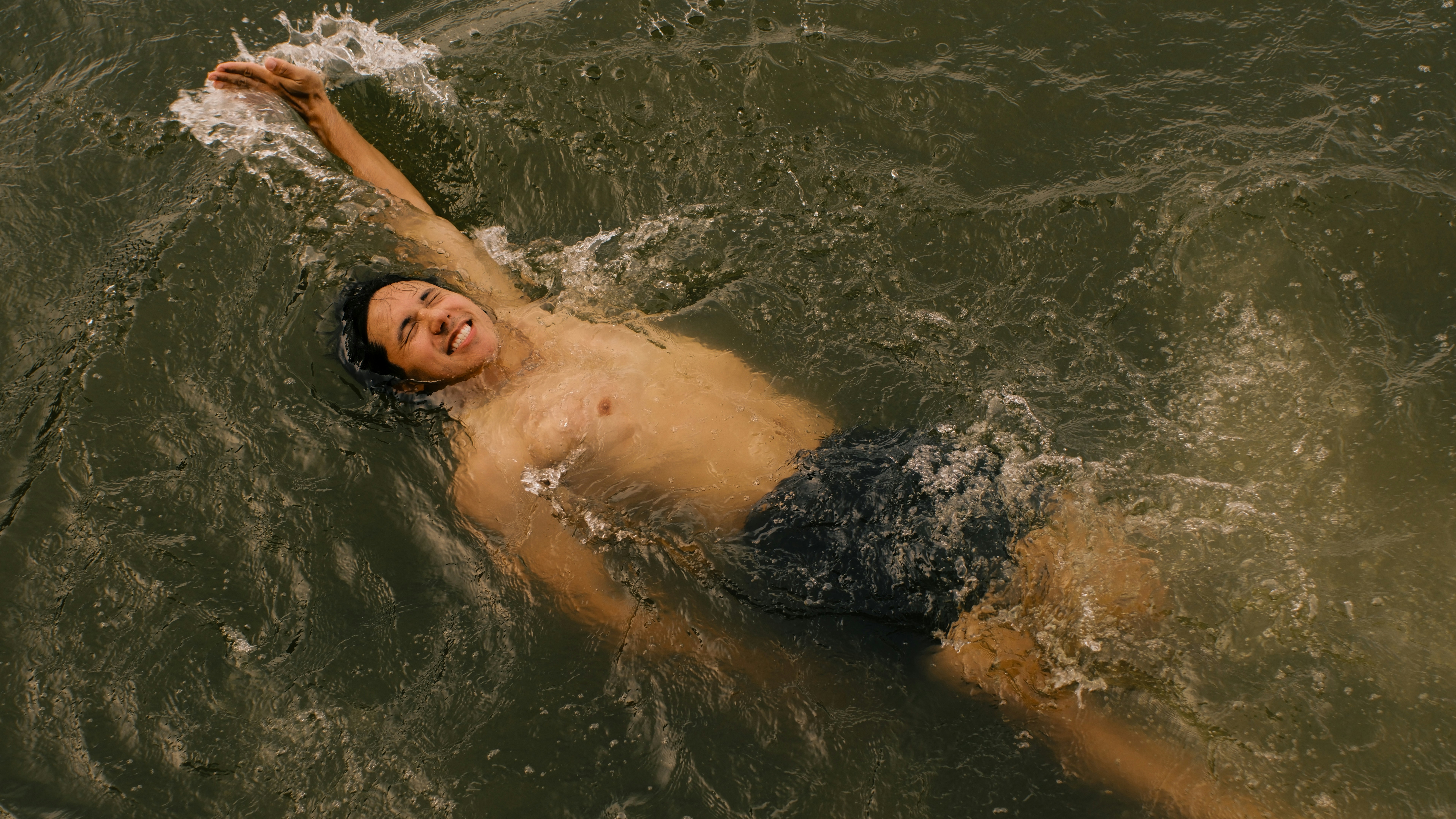 Floating Freedom: Man Surfs the Sea with Quiet Grit