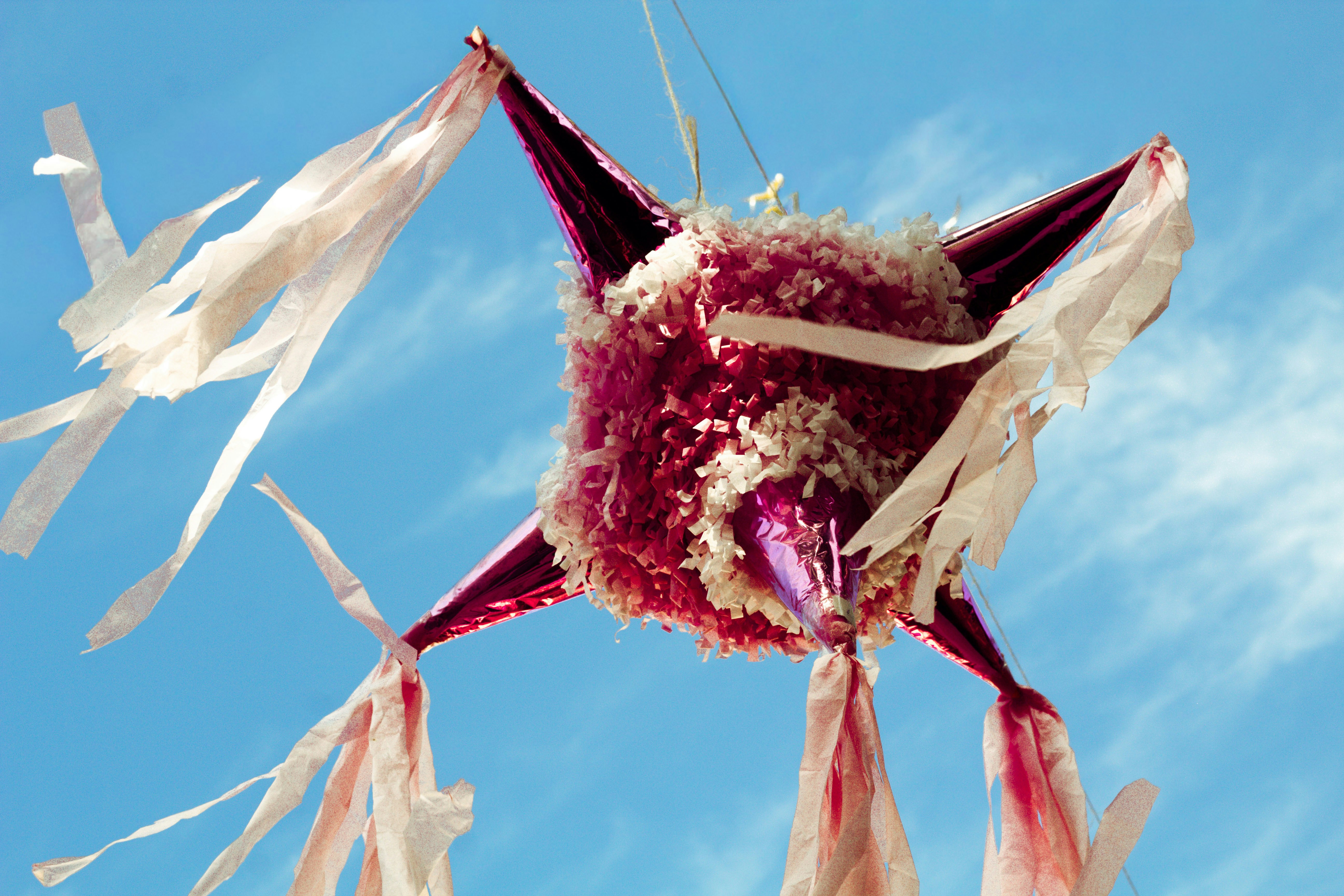 Skybound star with hanging ribbons: a festive ornament against a vivid blue