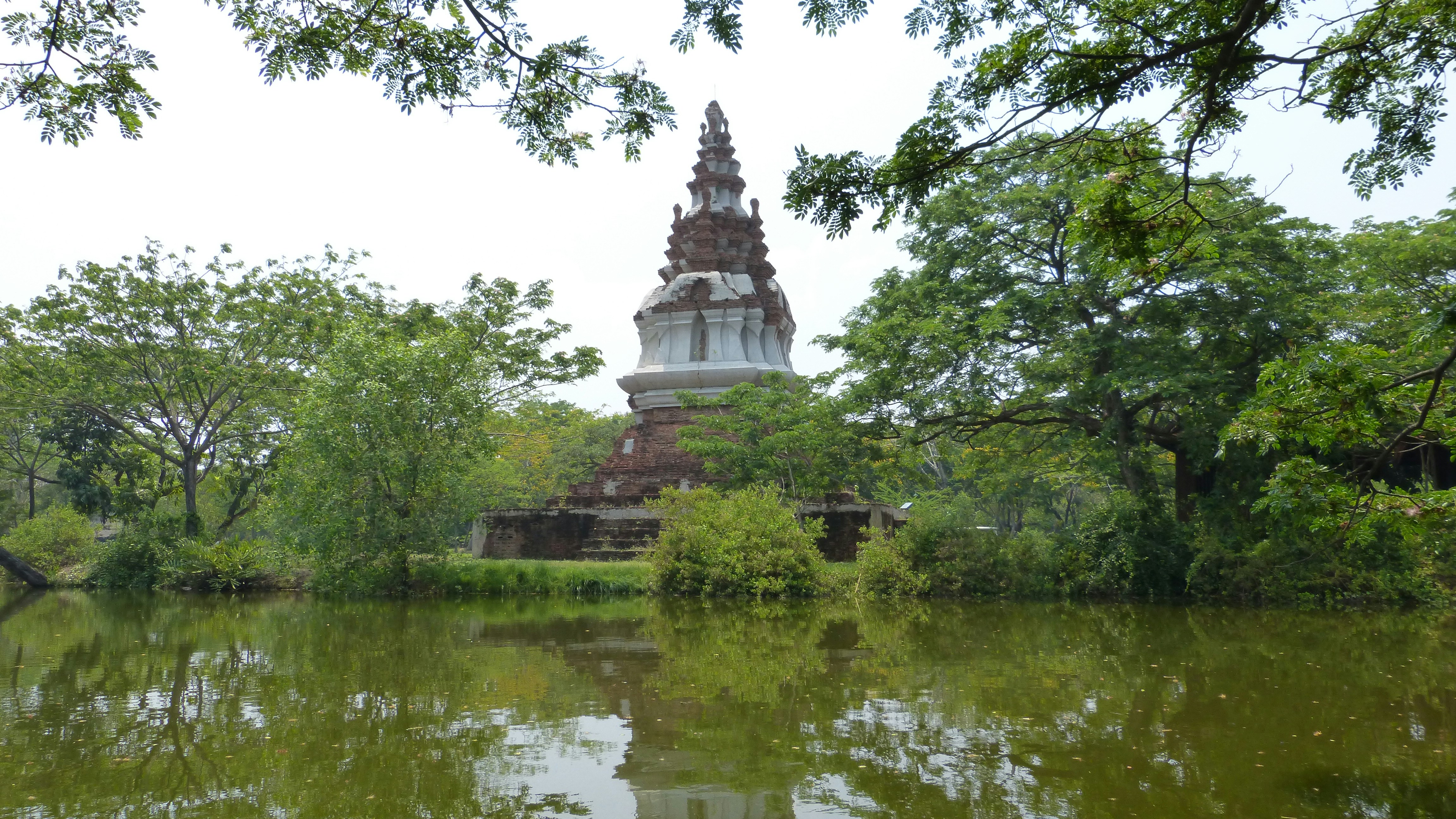 Temple in a Quiet Pond: A Serenity of Green and Stone