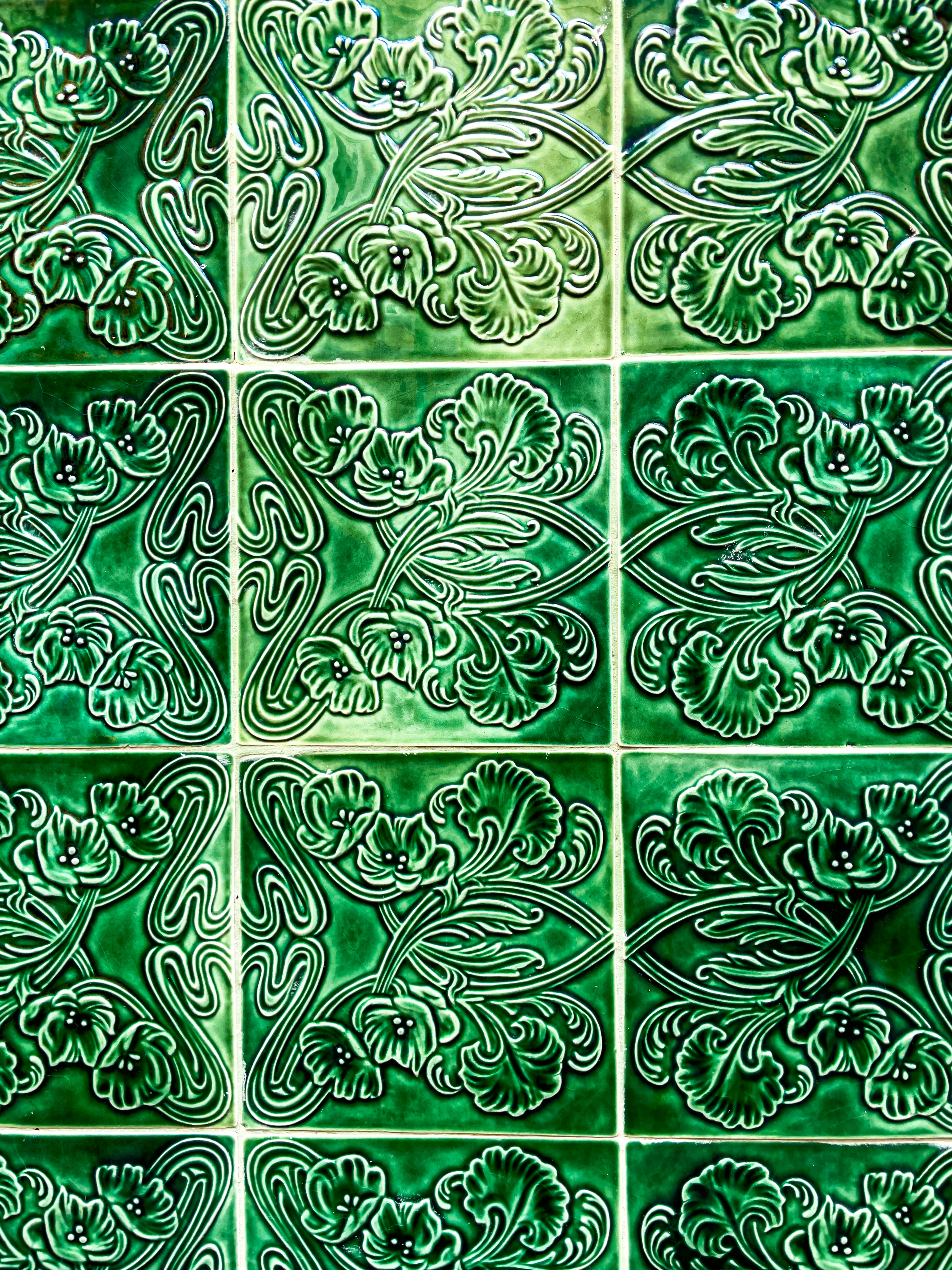 Emerald Tilework: Intricate Floral Reliefs in Lime-Green Mosaic