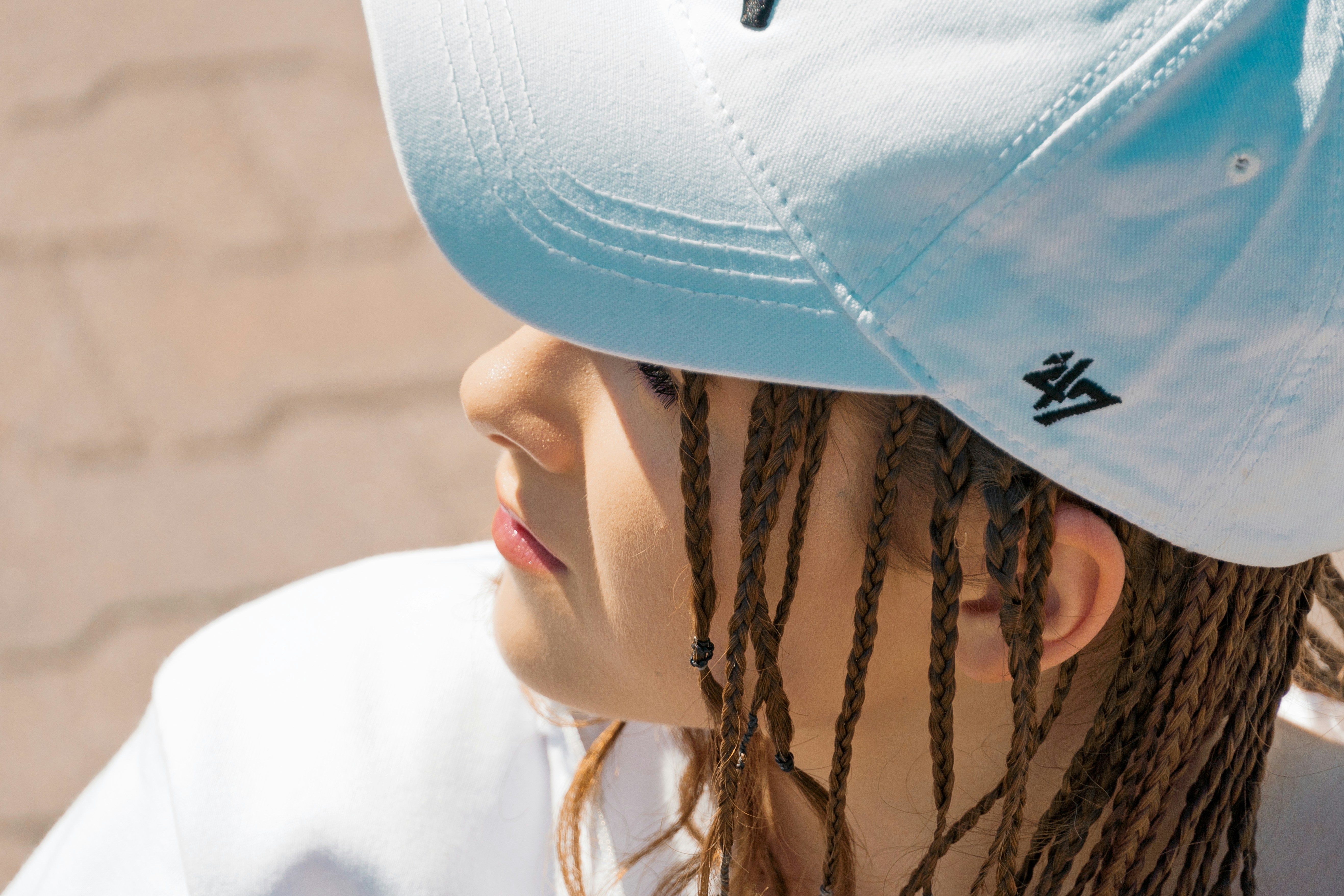 Hidden Profile in Soft Sunlight: A Side Glance from a Cap