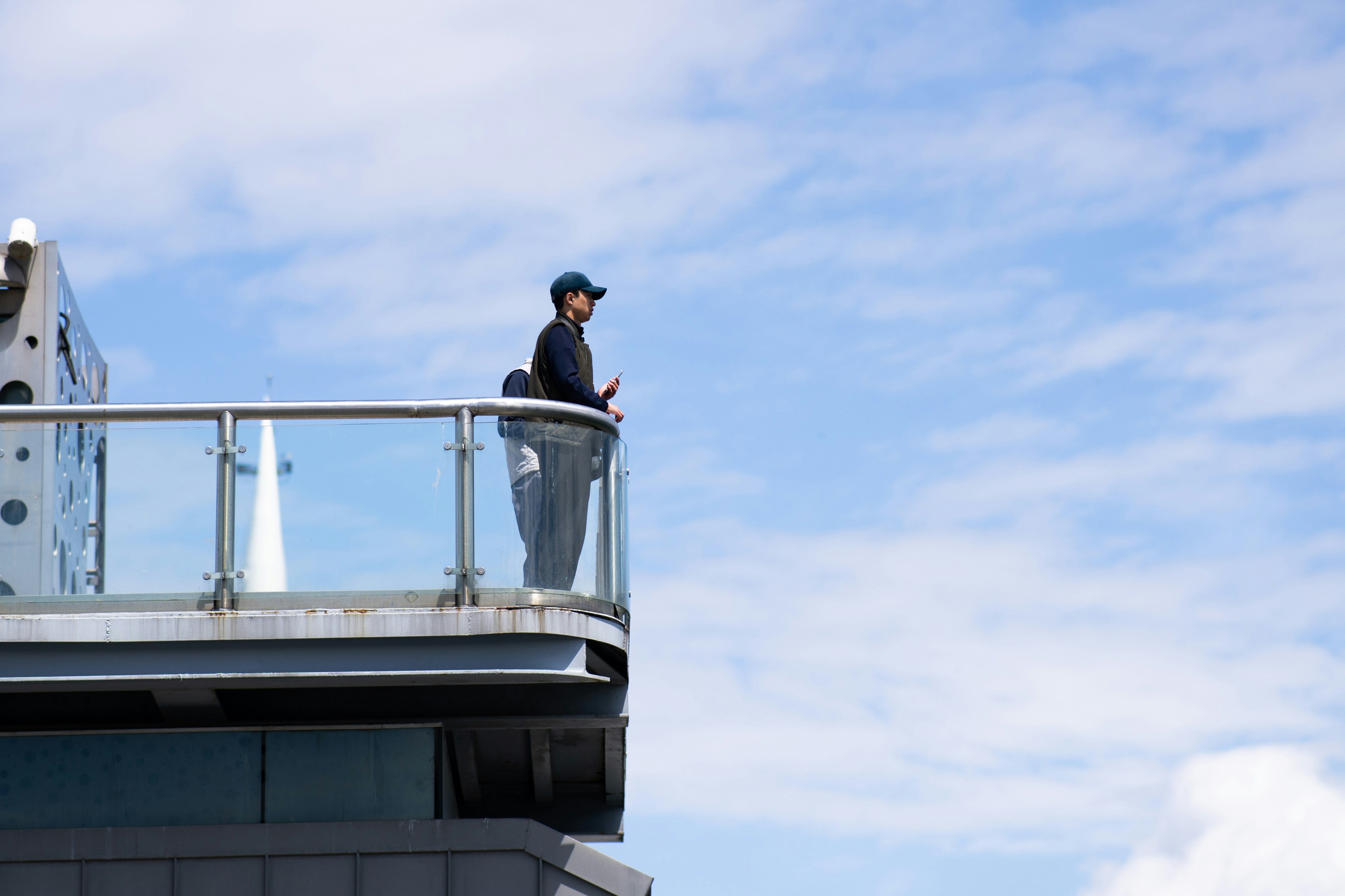 On the Edge: A Quiet Figure Overlooking the City