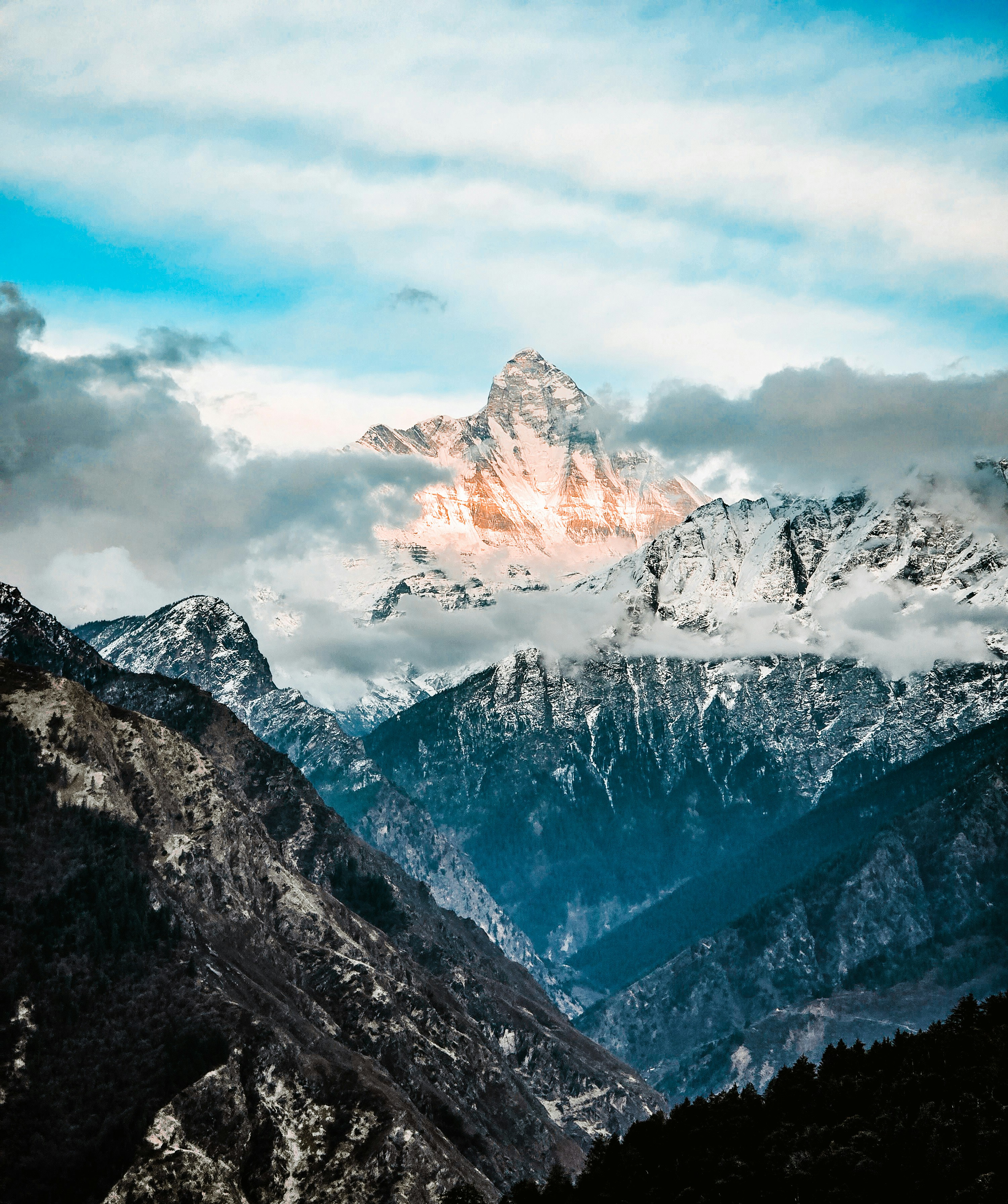 Snow-Capped Peak Emerges Through Oceanic Clouds at Dawn