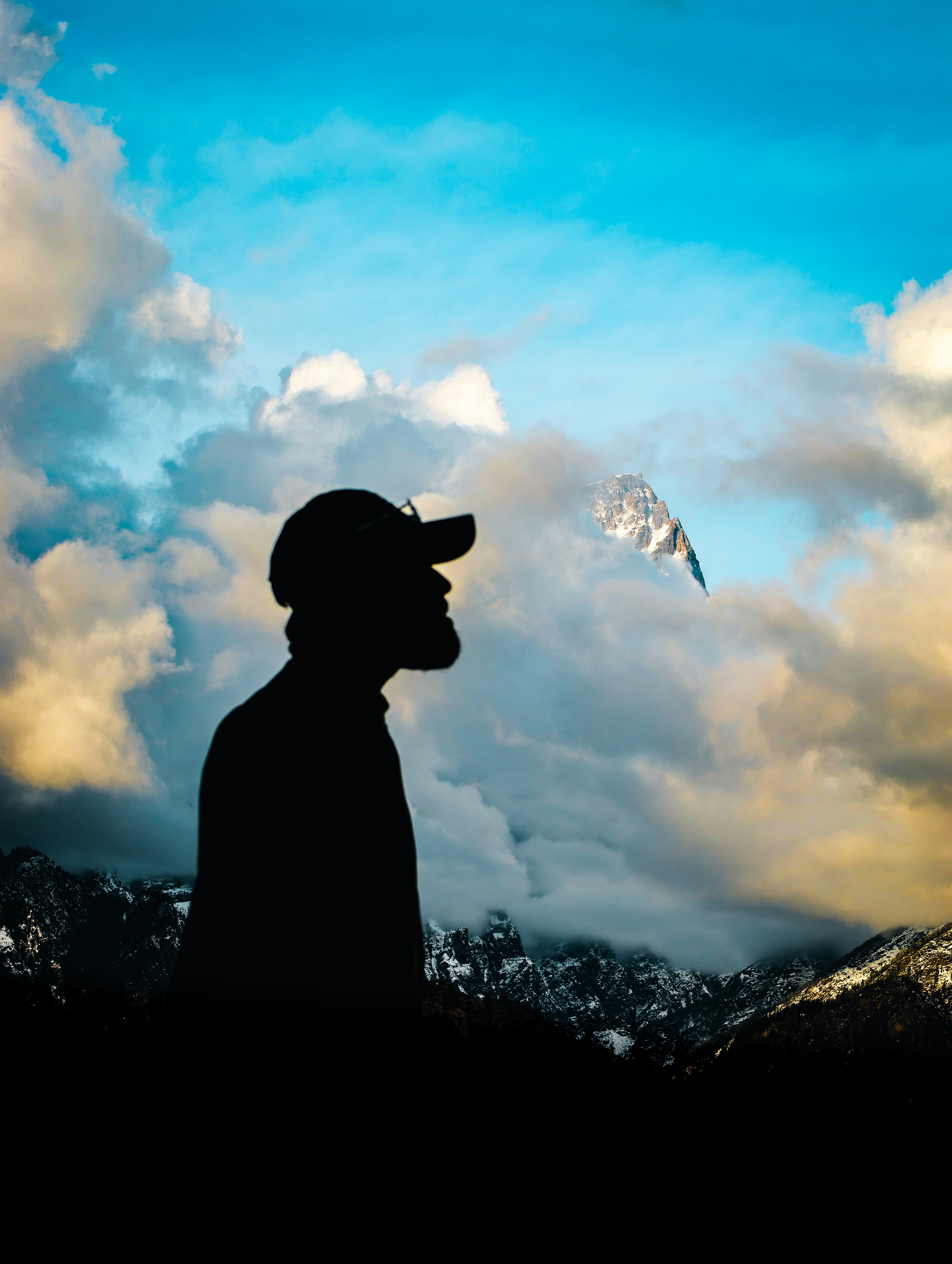 Silhouette against the Peaks: A Lone Adventurer Beneath Open Skies
