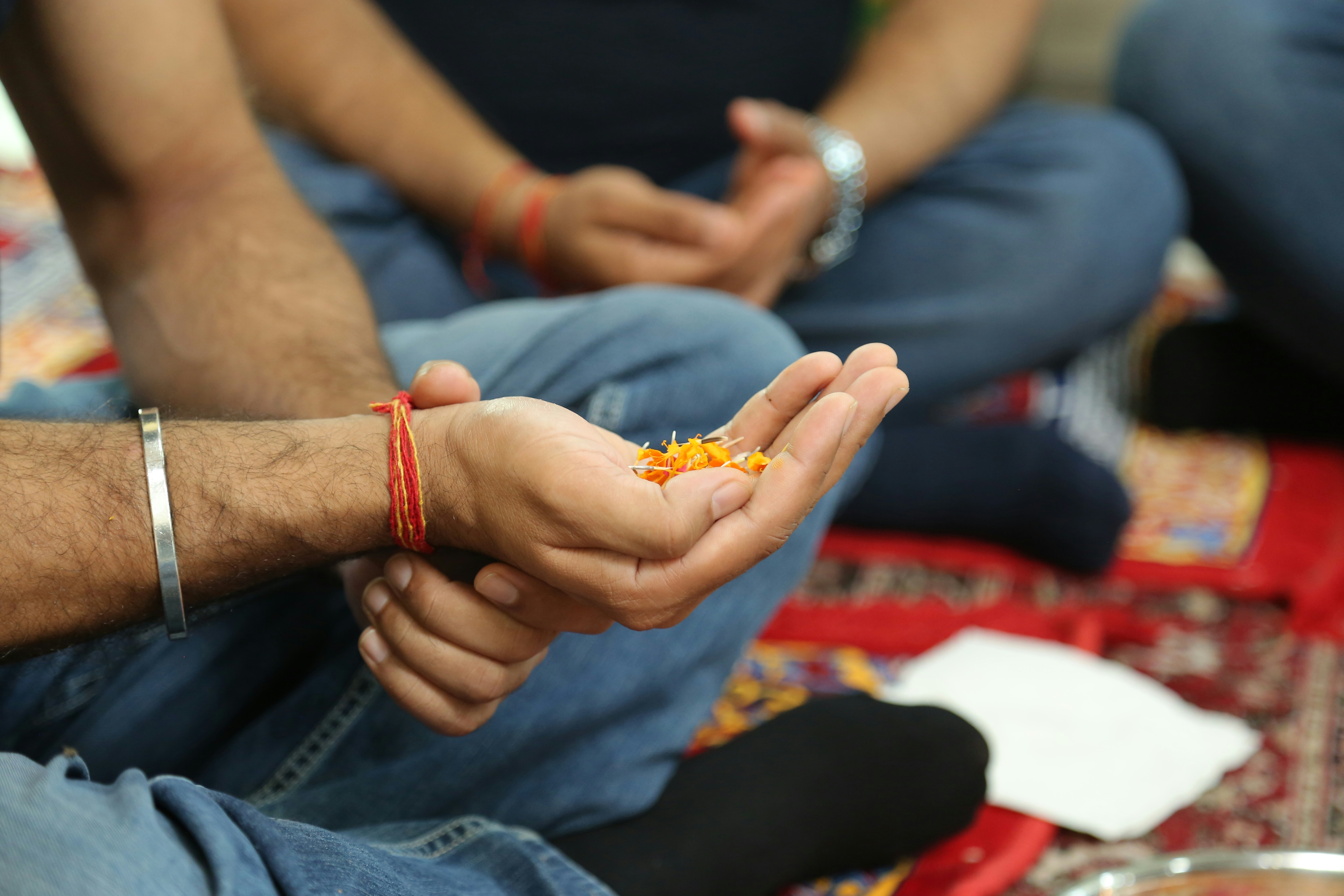Hands of Devotion: Offering Small Petals at a Quiet Gathering