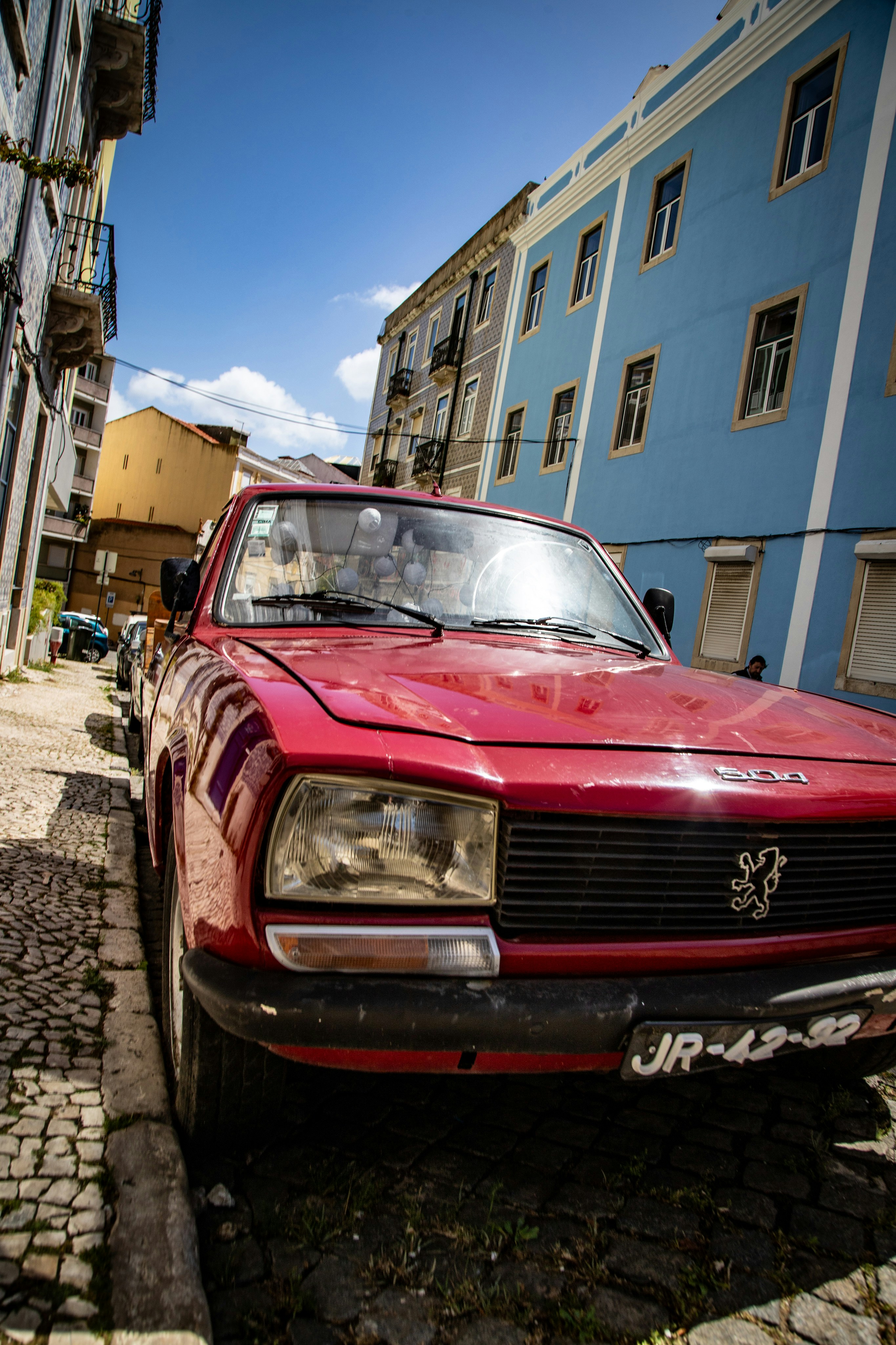 Red Peugeot in a Sunlit Portuguese Street
